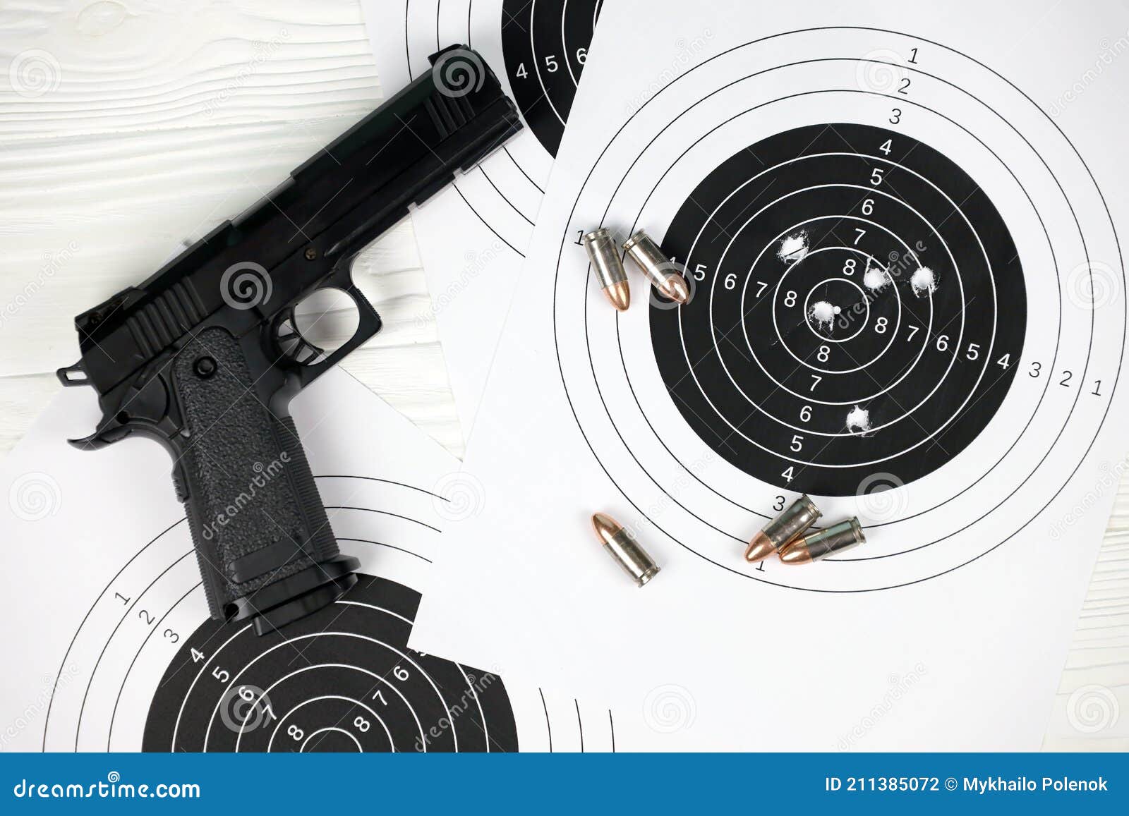 Gun and Many Bullets Shooting Targets on White Table in Shooting Range ...