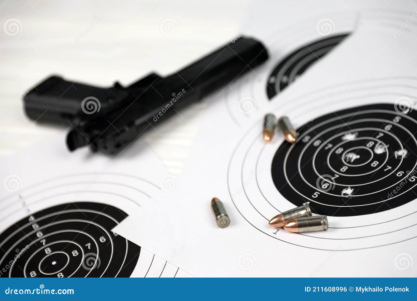 Gun and Many Bullets Shooting Targets on White Table in Shooting Range ...