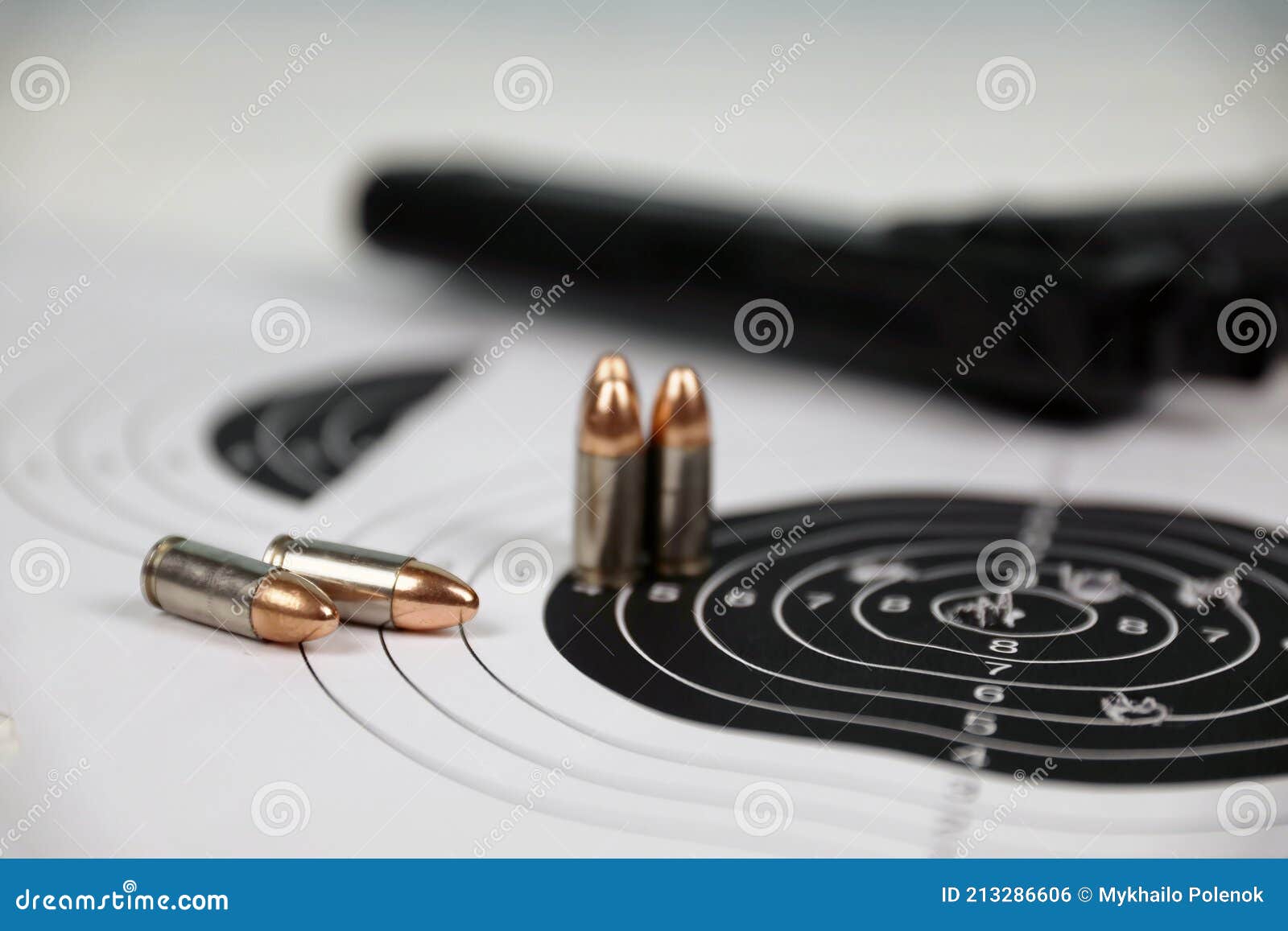 Gun and Many Bullets Shooting Targets on White Table in Shooting Range ...