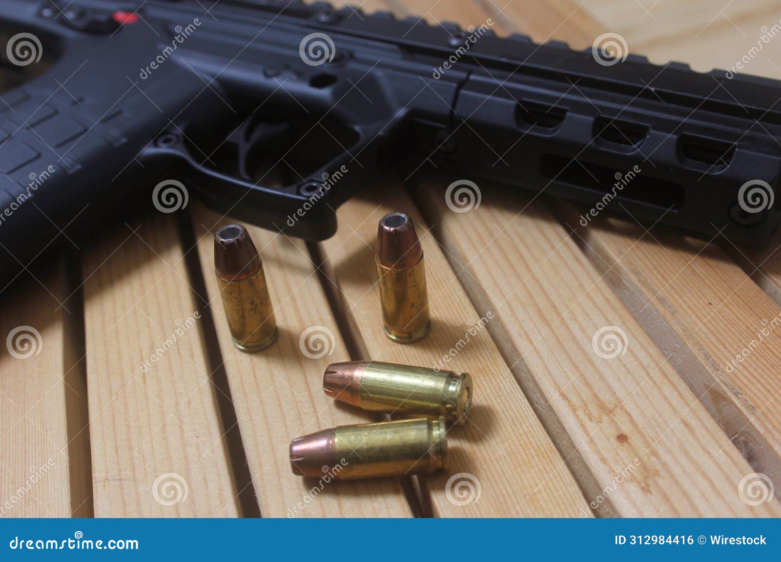 A Gun Laying on Top of Bullet Shells on a Table Stock Photo - Image of ...