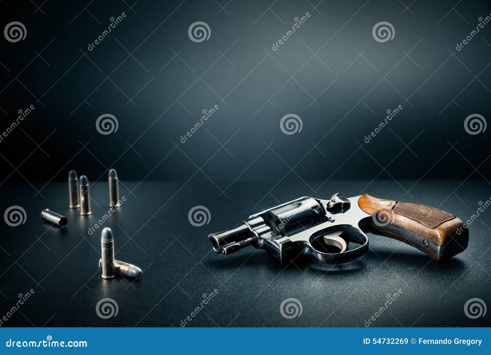 Gun Sitting on a Table with Bullet Shells / Dramatic Lighting Stock ...