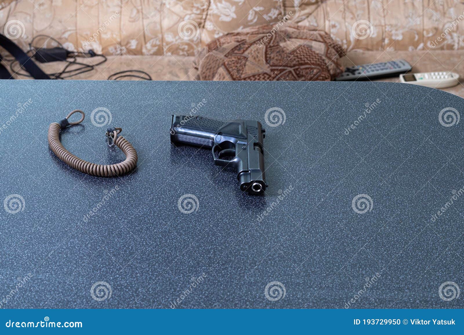 The Gun is on the Table. Pistol and Sling on the Home Table. Storing a ...