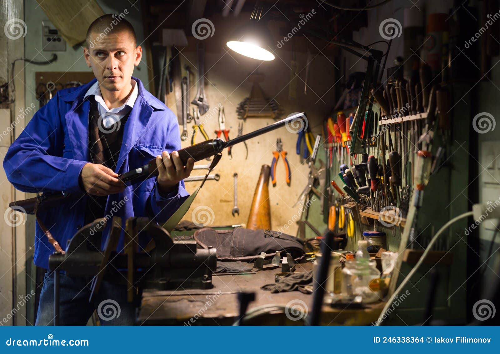 Gunsmith Examines an Automatic Rifle before Being Repaired in Weapons ...