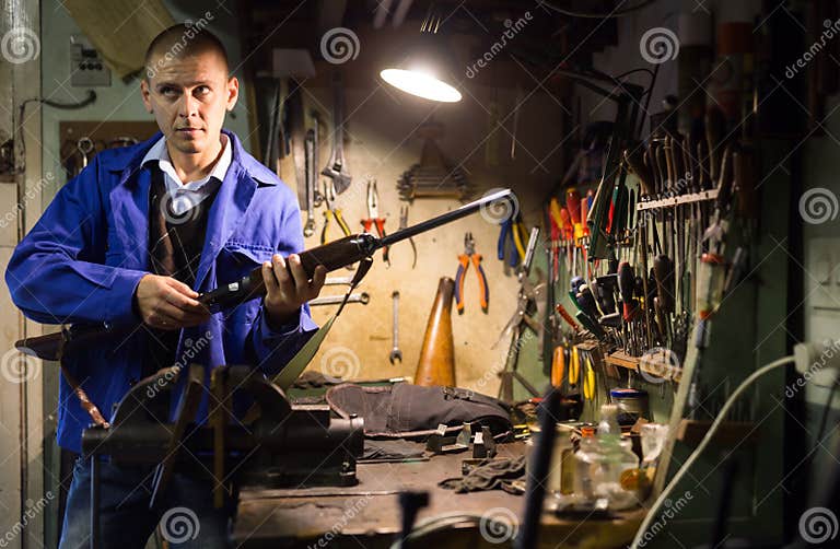 Gunsmith Examines an Automatic Rifle before Being Repaired in Weapons ...