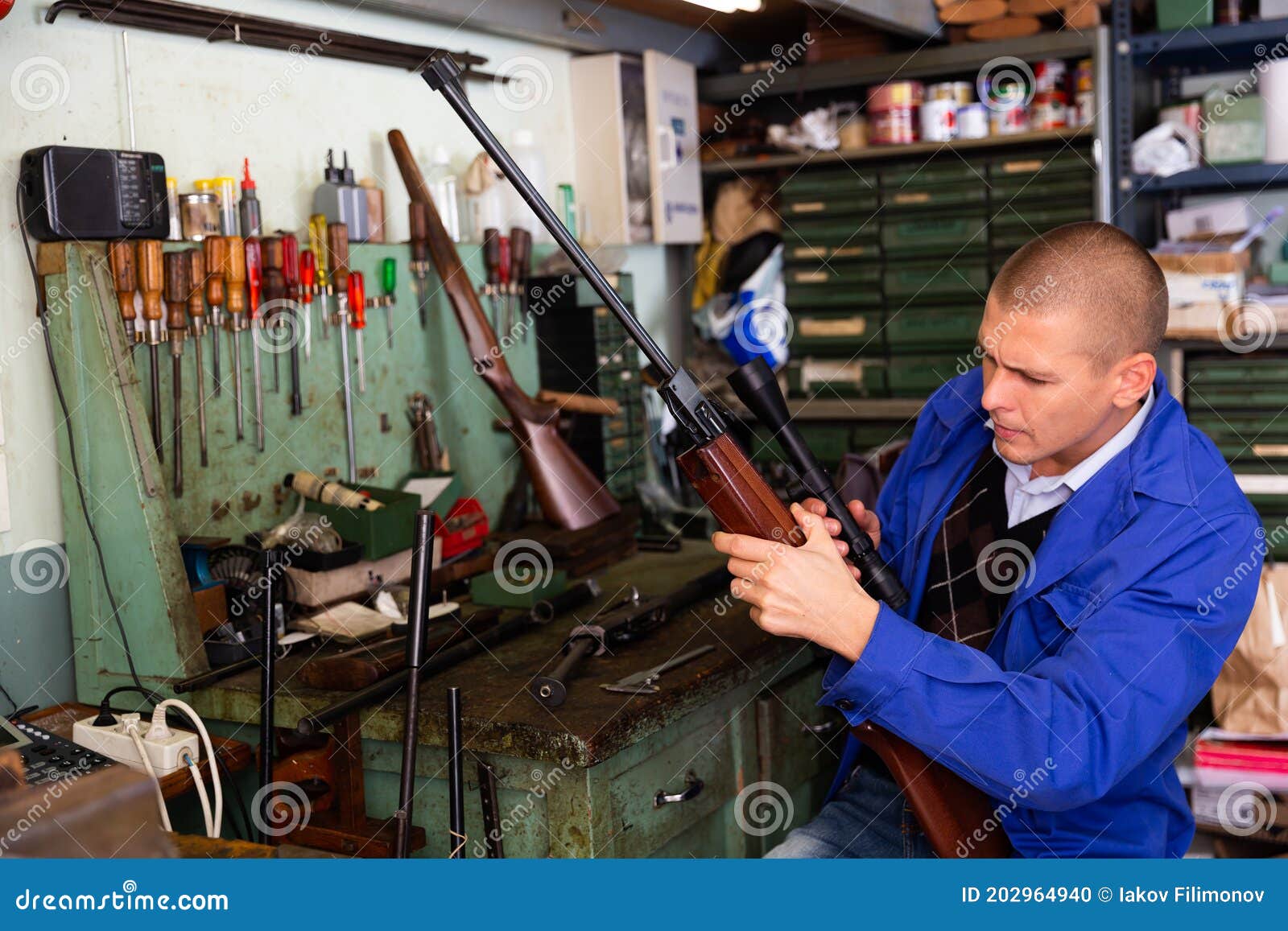 Gunsmith Installing Optical Sight on Rifle in Weapons Workshop Stock ...