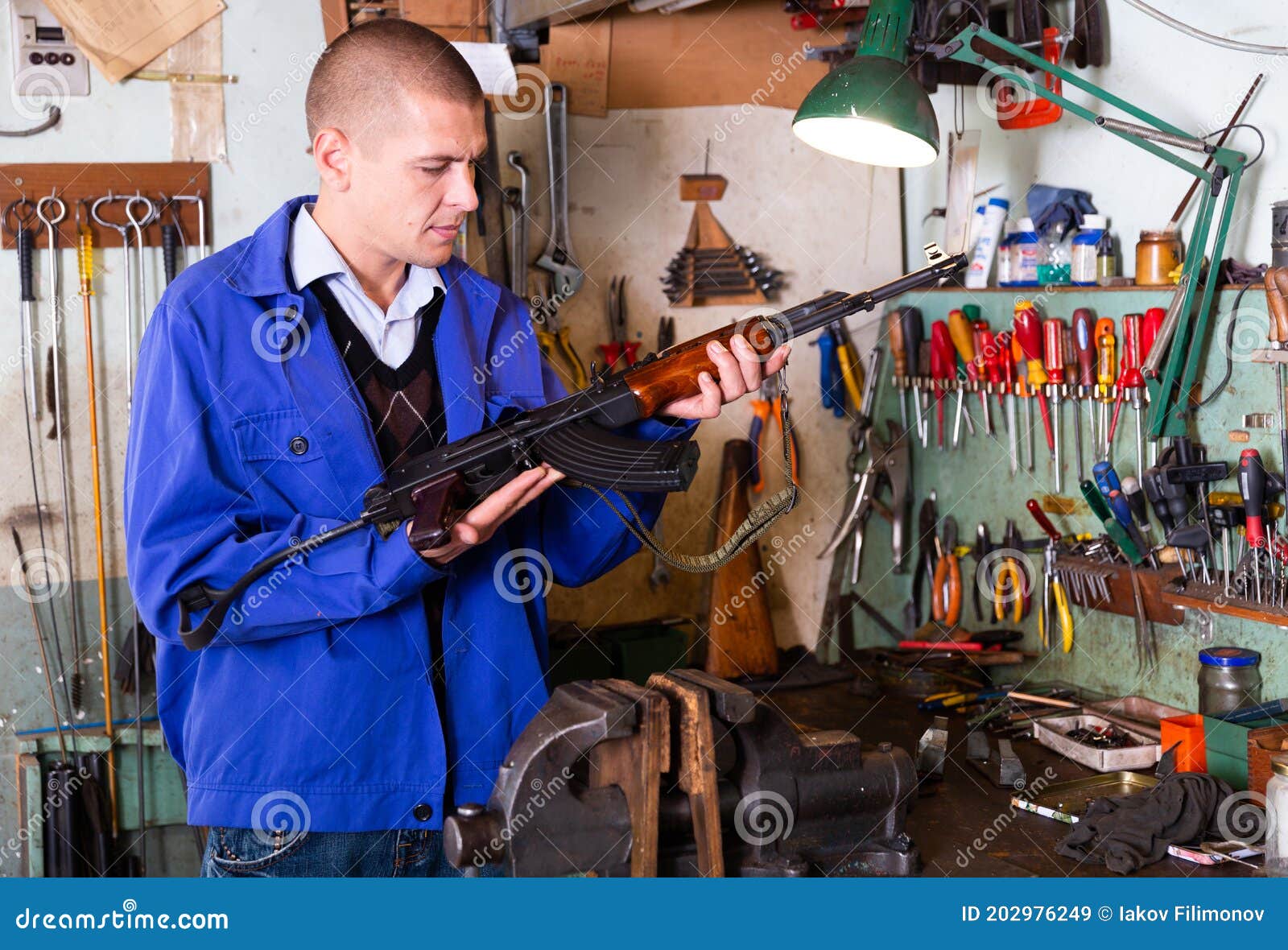 Gunsmith with Kalashnikov Assault Rifle in Weapons Workshop Stock Image ...