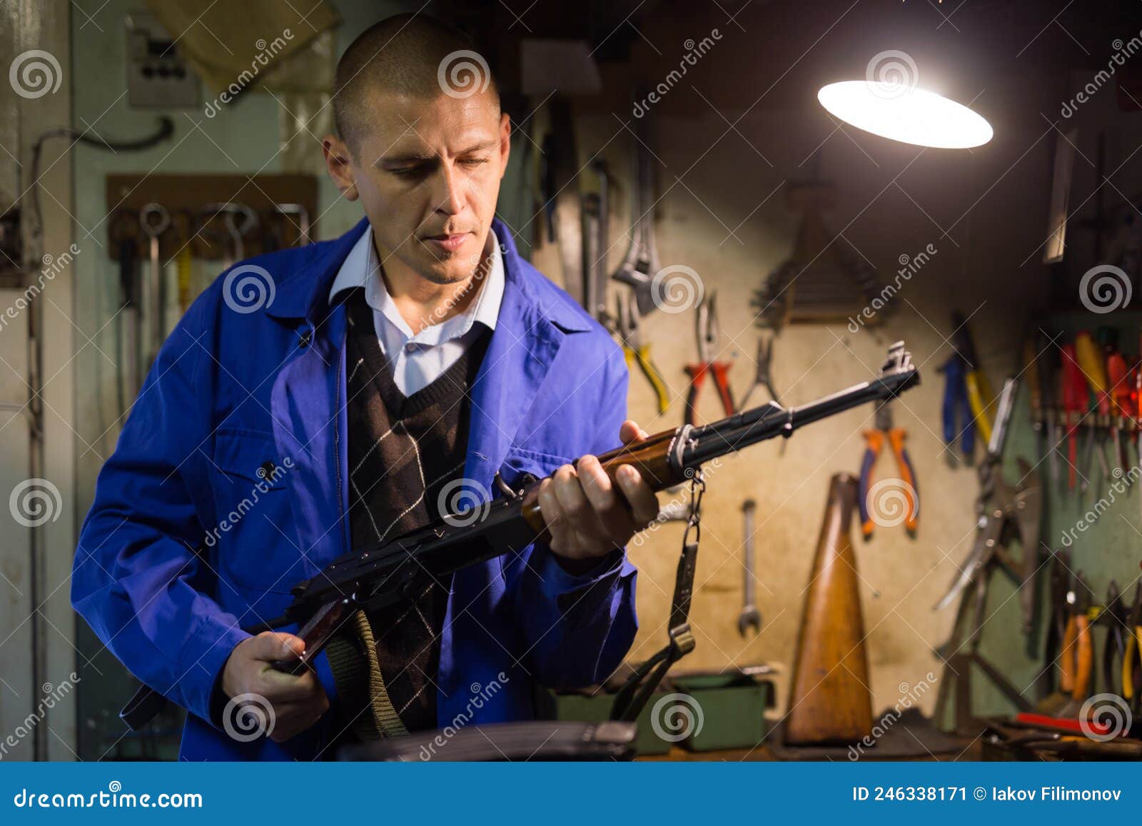 Gunsmith with Kalashnikov Assault Rifle in Weapons Workshop Stock Image ...