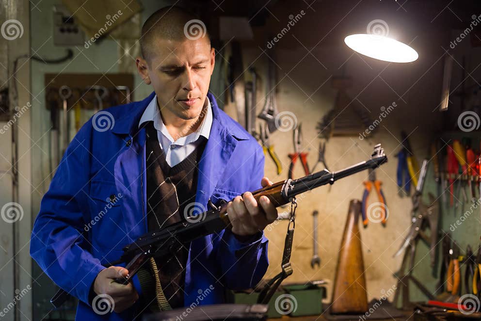 Gunsmith with Kalashnikov Assault Rifle in Weapons Workshop Stock Image ...