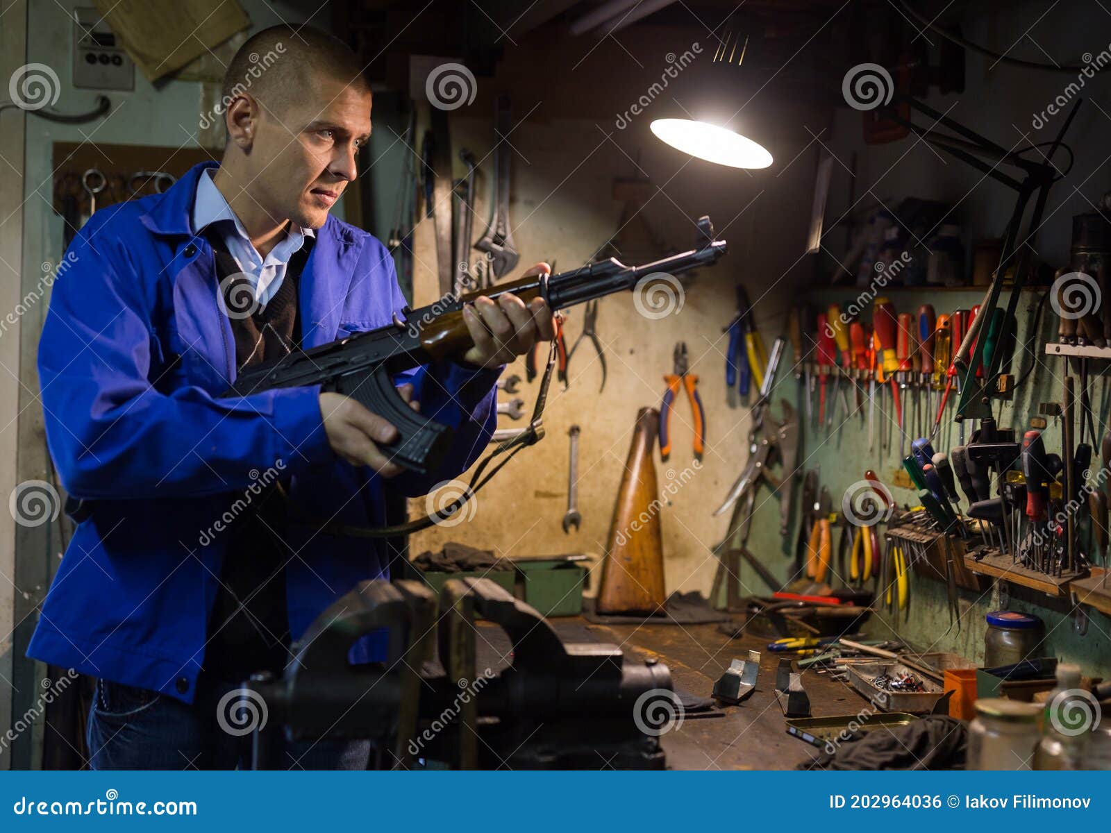 Gunsmith with Kalashnikov Assault Rifle in Weapons Workshop Stock Photo ...