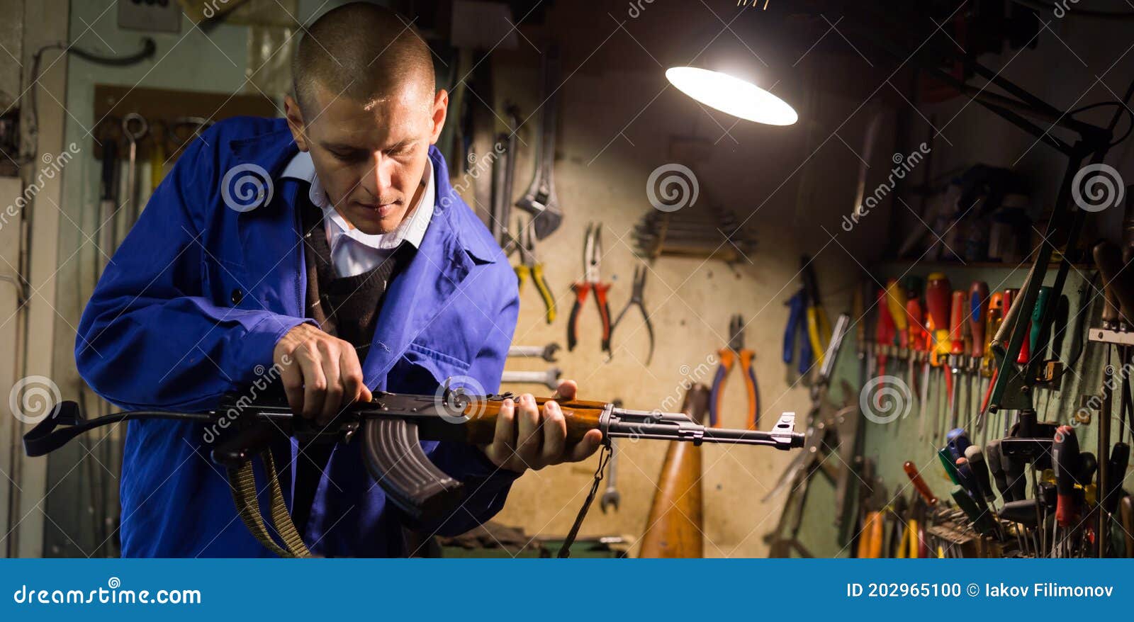 Gunsmith with Kalashnikov Assault Rifle in Weapons Workshop Stock Photo ...
