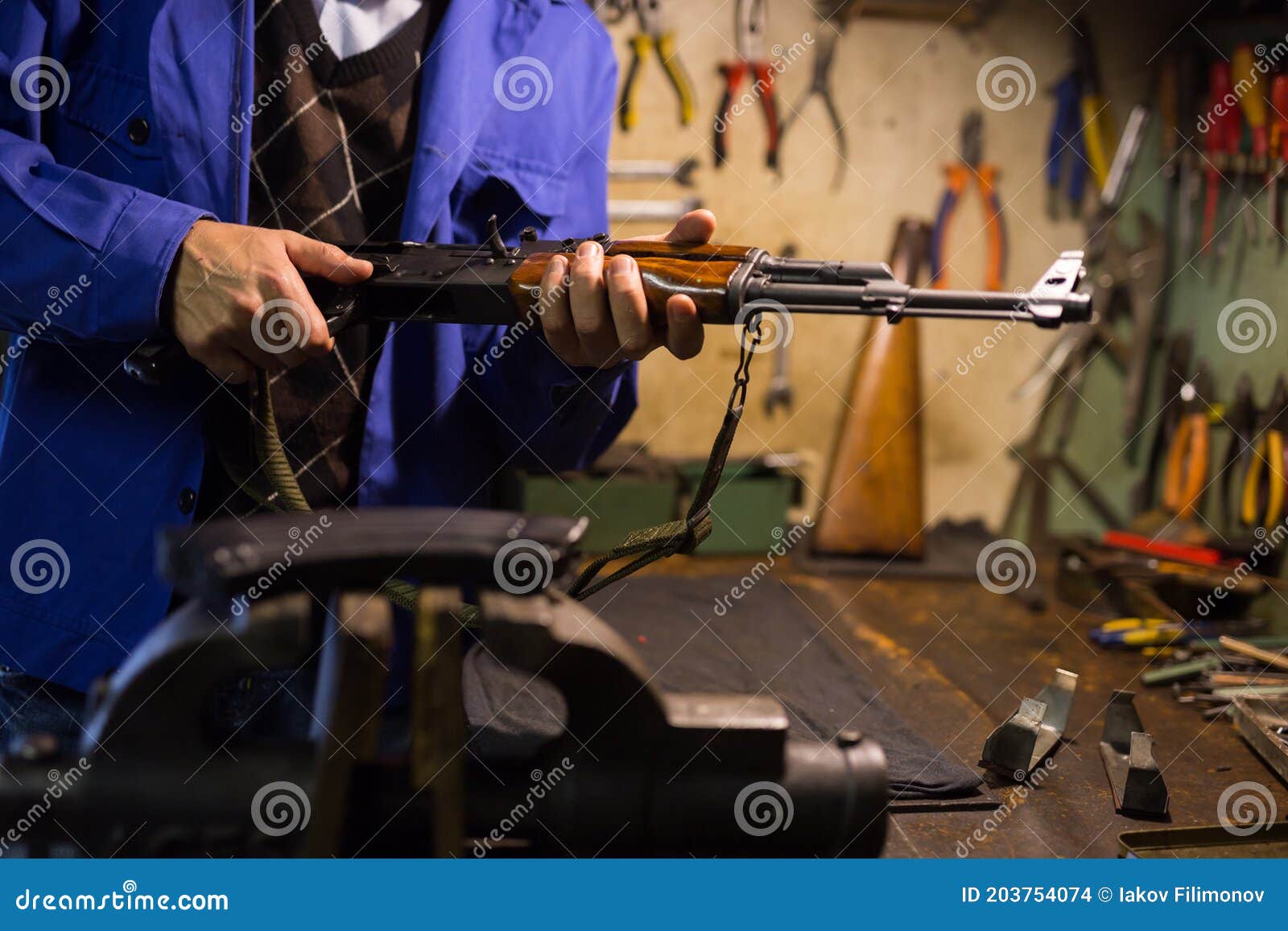 Gunsmith with Kalashnikov Assault Rifle in Weapons Workshop Stock Photo ...