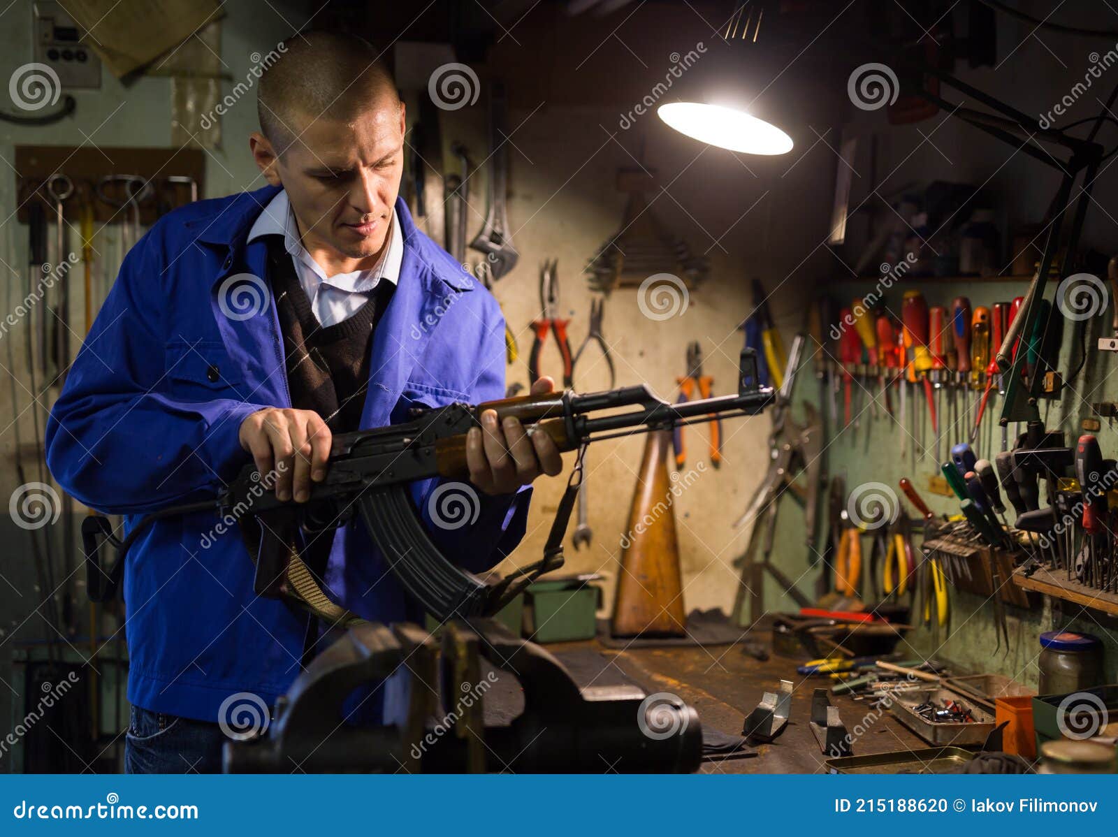 Gunsmith with Kalashnikov Assault Rifle in Weapons Workshop Stock Photo ...