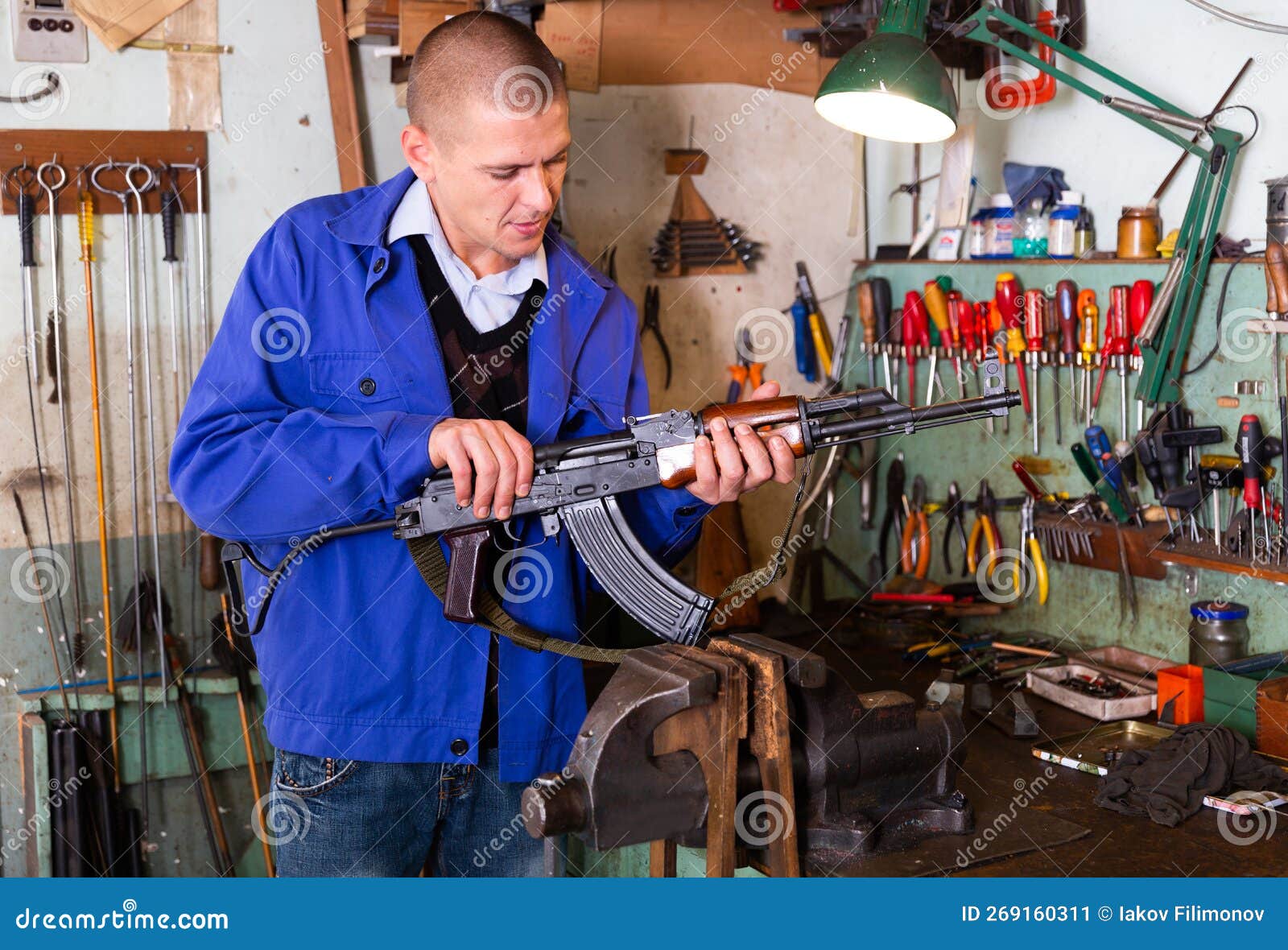Gunsmith with Kalashnikov Assault Rifle in Weapons Workshop Stock Image ...