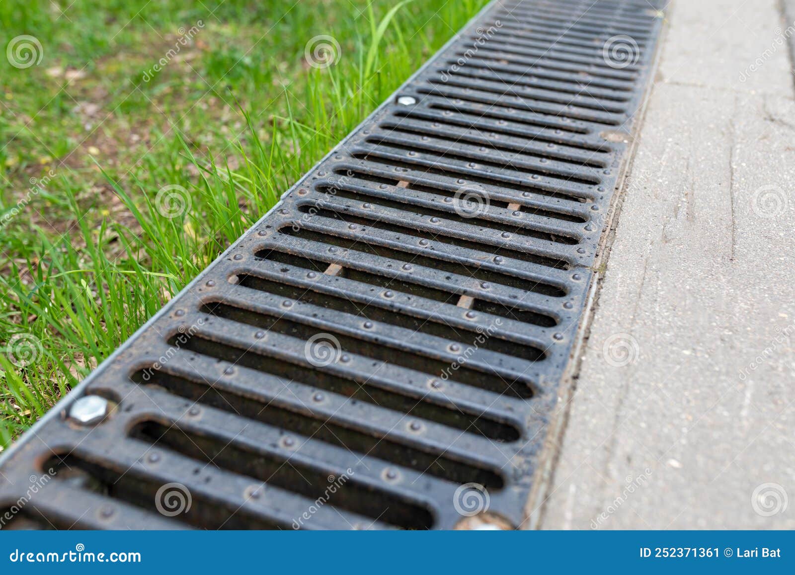 A Gutter, a Drain for Rainwater on the Border of a Lawn and a ...