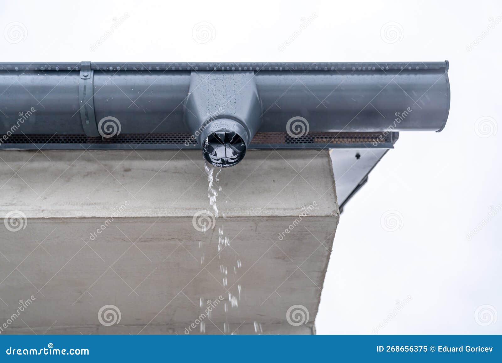 Gutter with Flowing Rainwater on the Roof of the Building Stock Image ...
