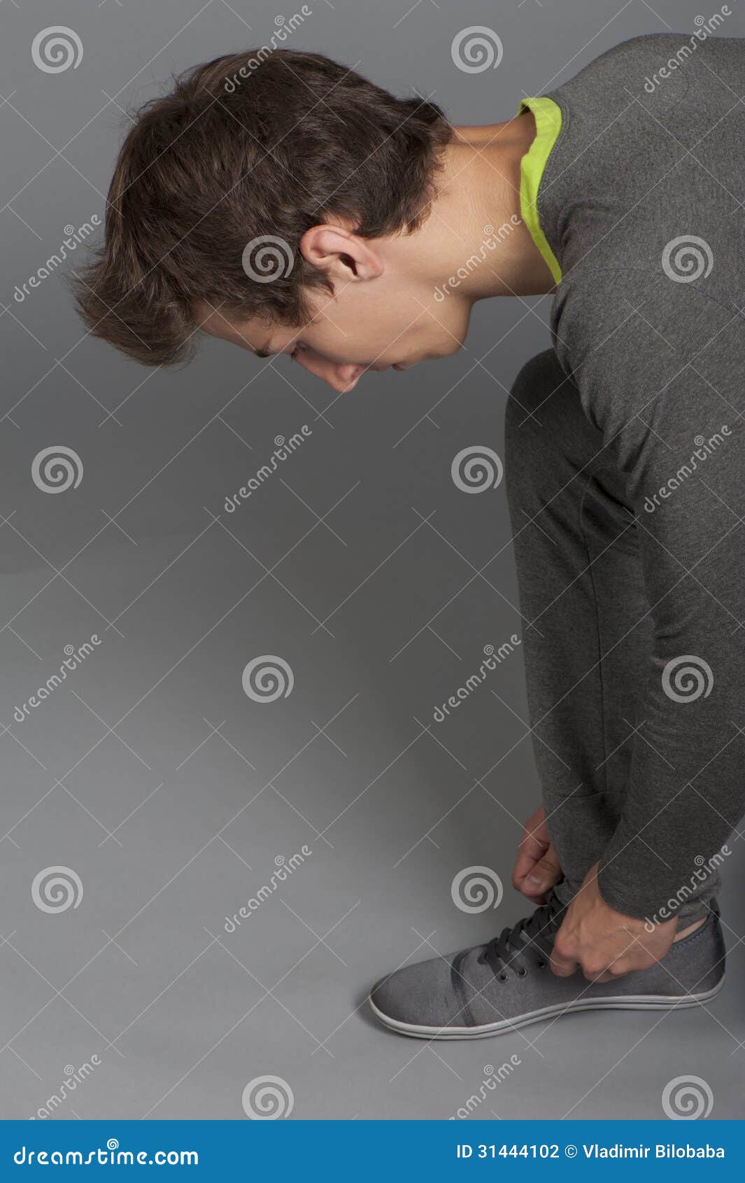Guy adjusts his shoes stock photo. Image of adjusts, person - 31444102