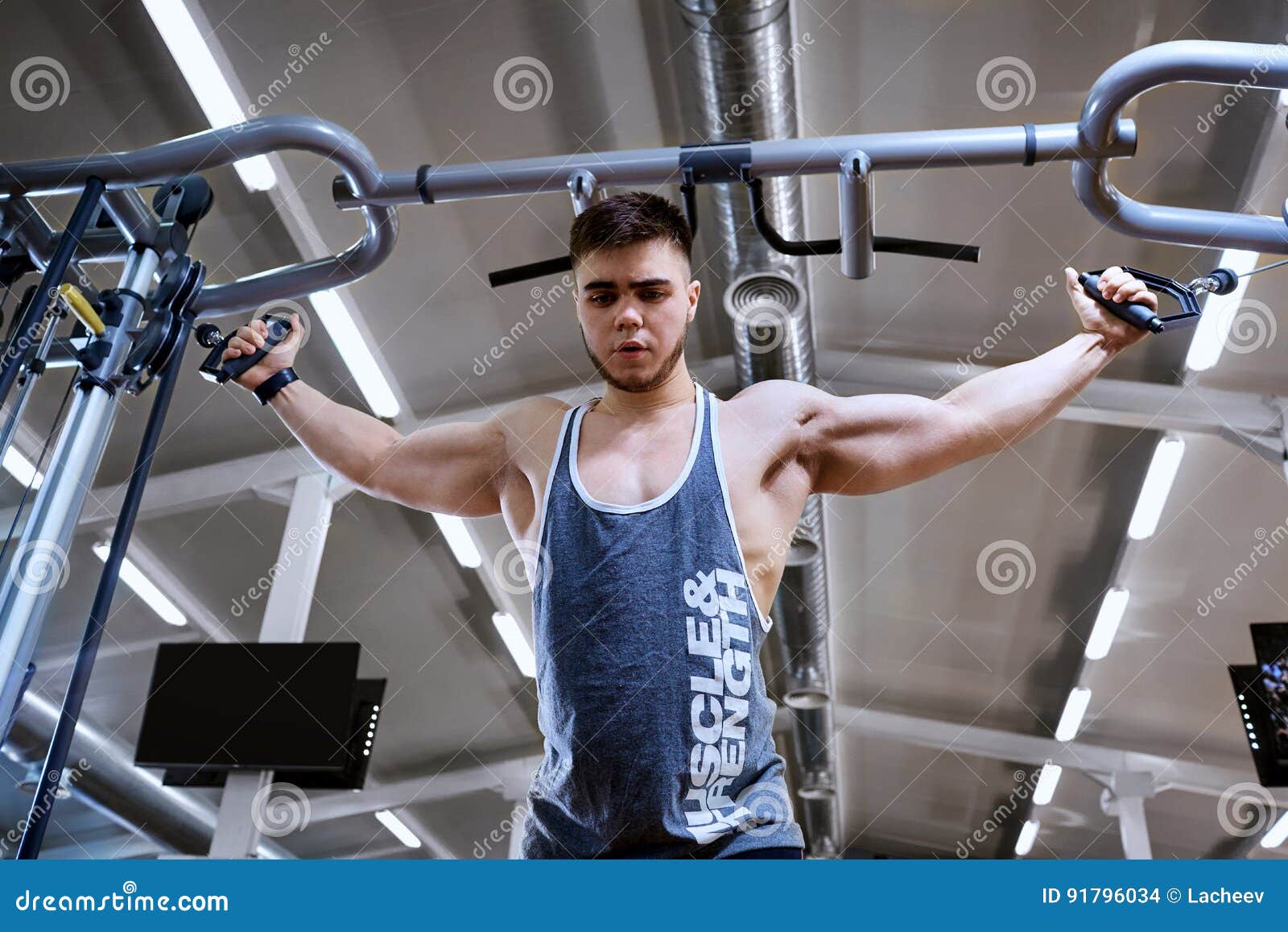 A Guy Athlete Does Exercises on Simulator in the Gym Stock Photo ...