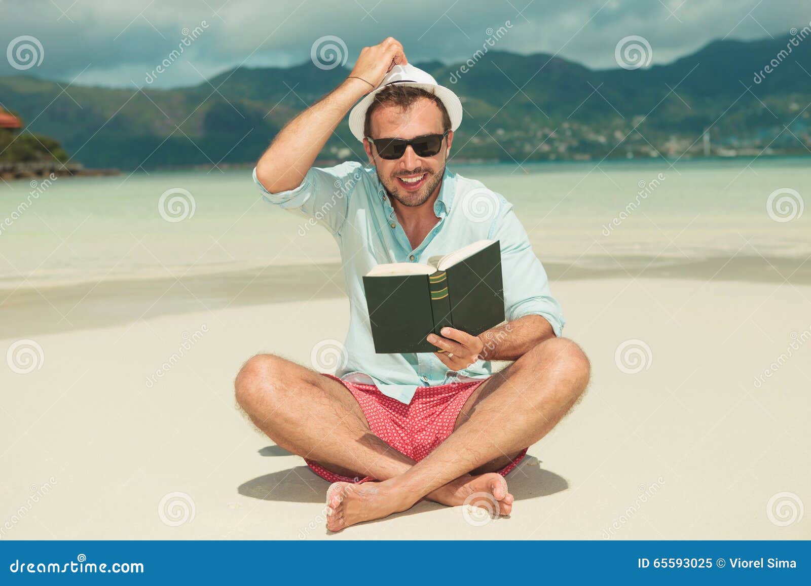 Guy on the Beach Reading a Green Book Stock Image - Image of away ...