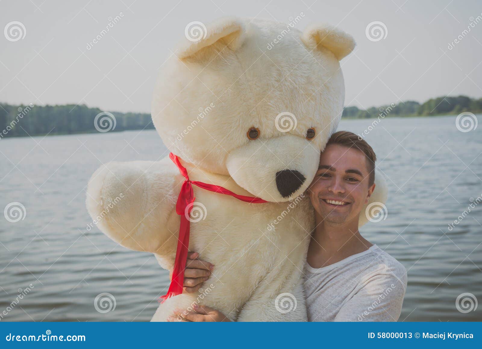 Guy with a big teddy bear stock image. Image of companion - 58000013