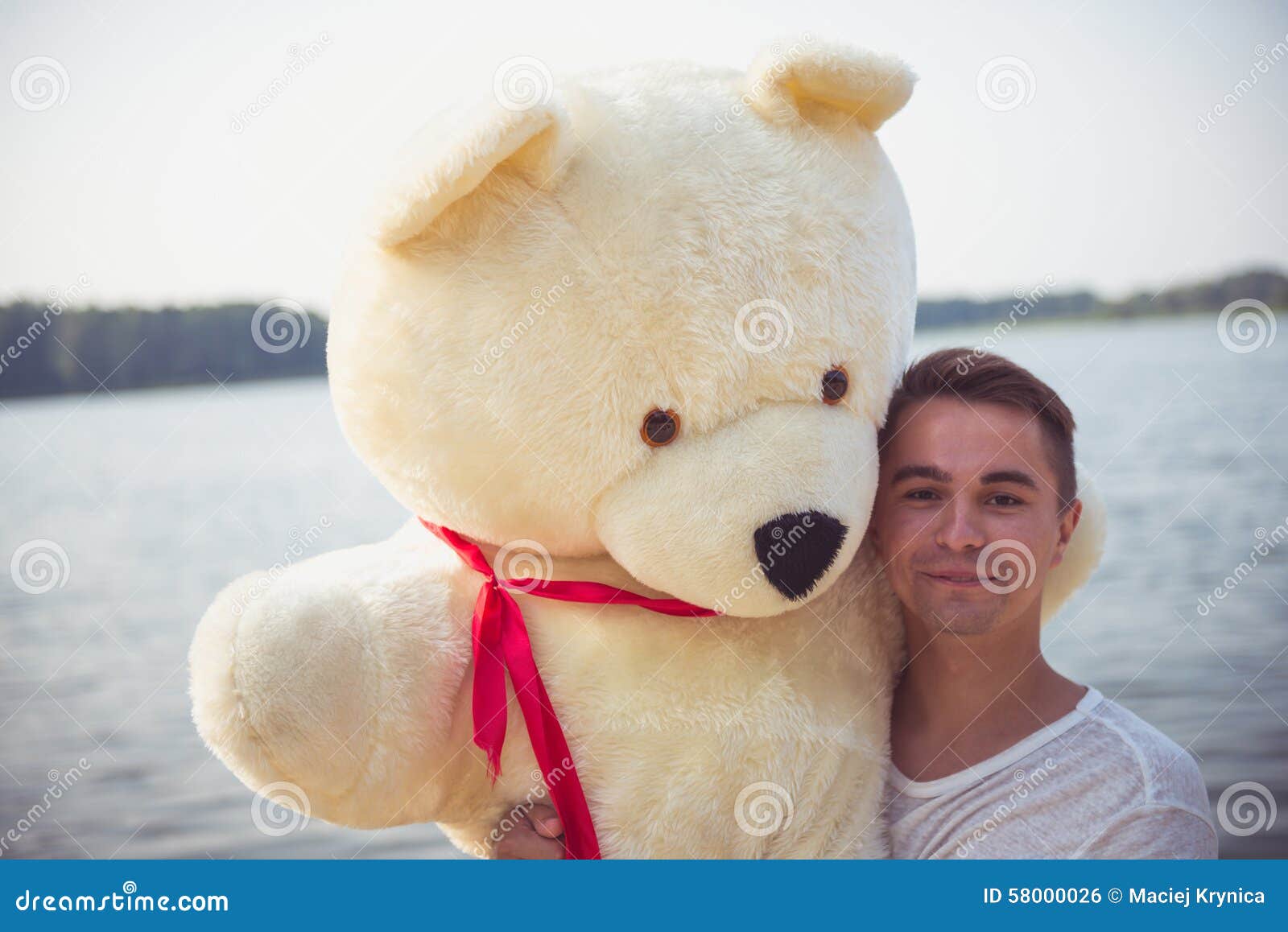 Guy with a big teddy bear stock photo. Image of lovely - 58000026