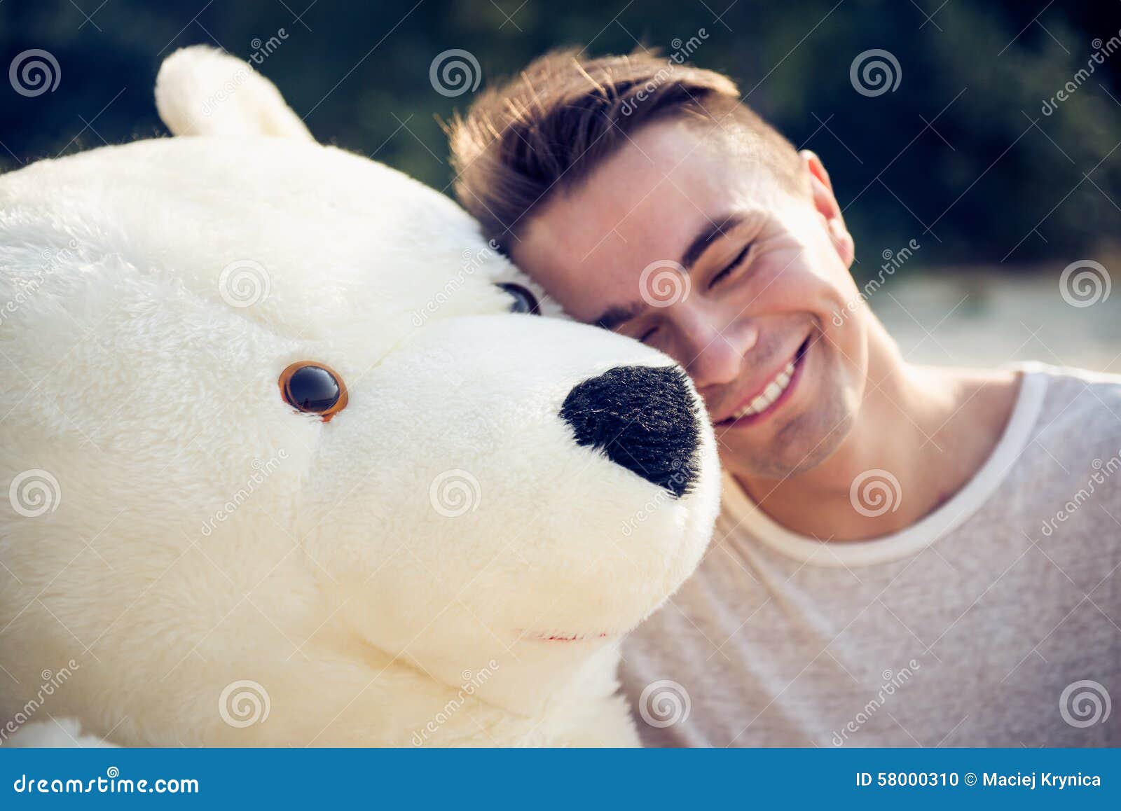 Guy with a big teddy bear stock photo. Image of cute - 58000310