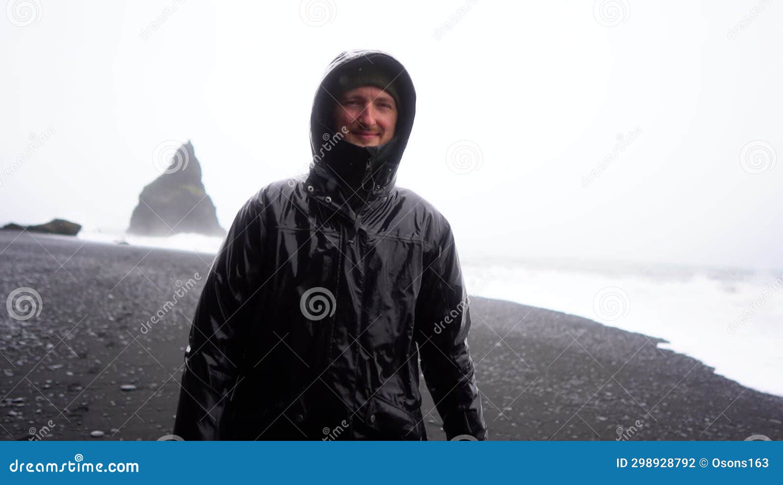 A Guy in a Black Raincoat Walks in the Rain and Storm Along a Black ...