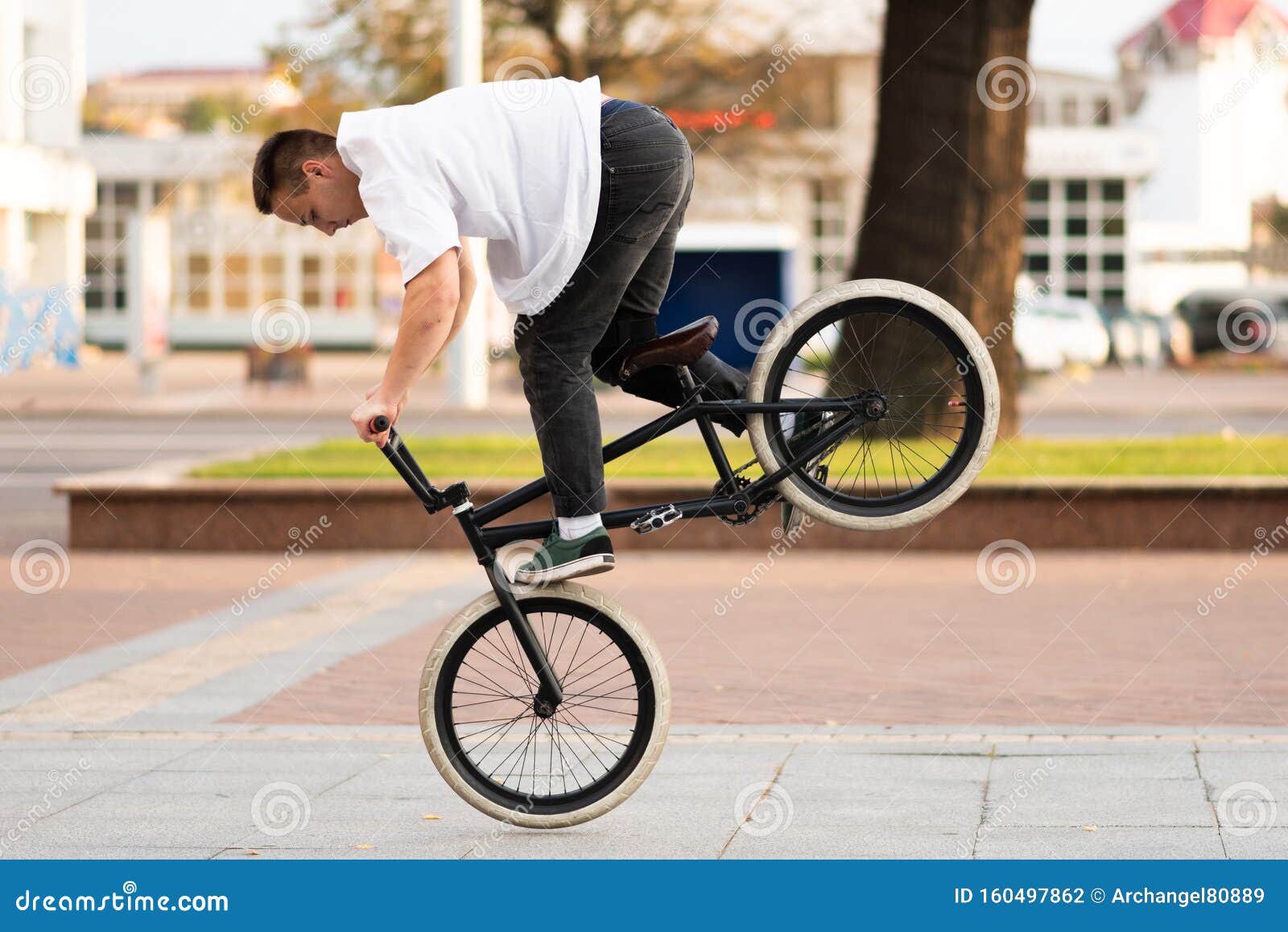 The Guy on the BMX Bike Performs a Trick on the Front Wheel Stock Photo ...