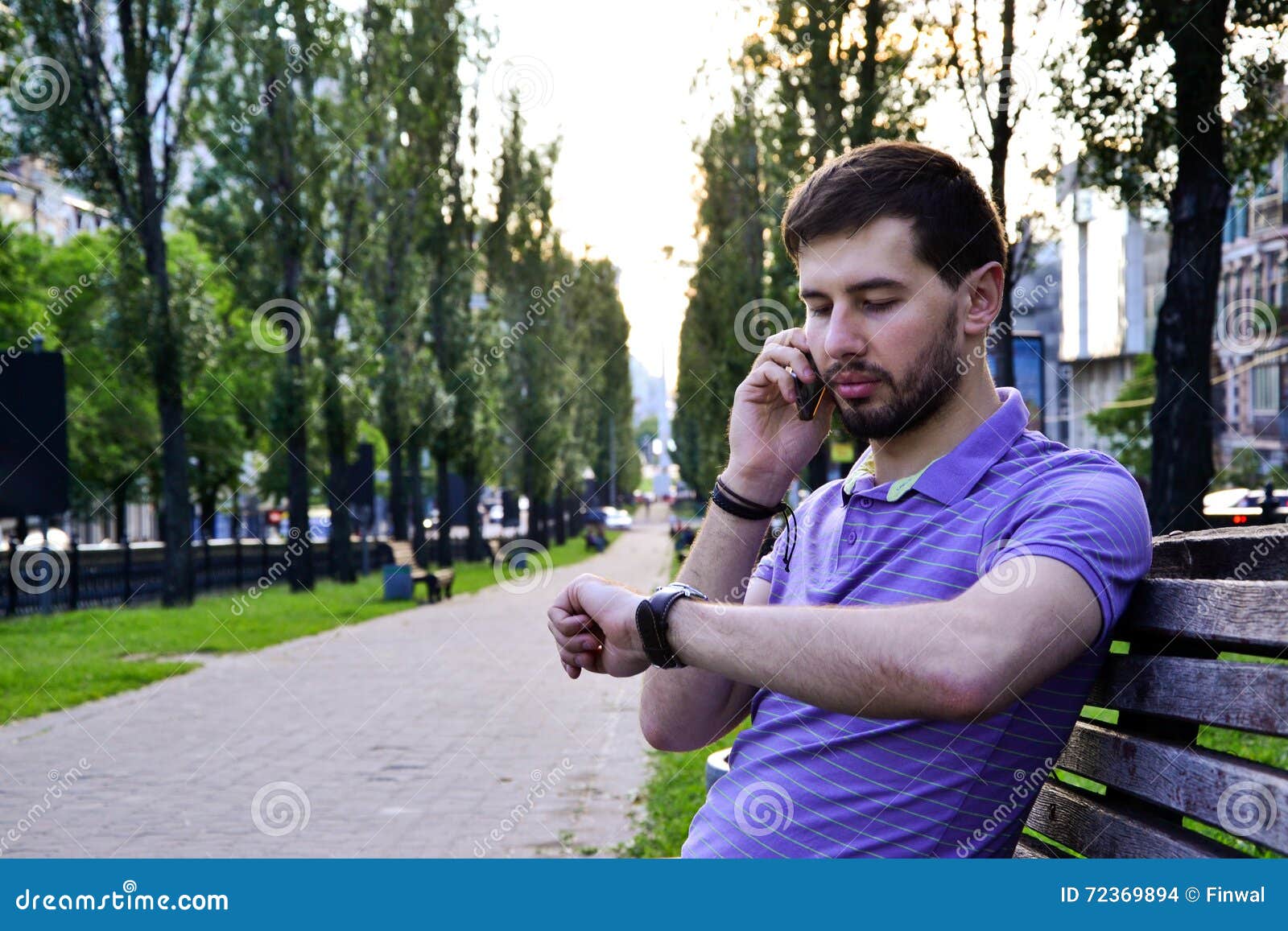 Guy Calling on the Phone Looking at the Watch Outdoors Stock Photo ...