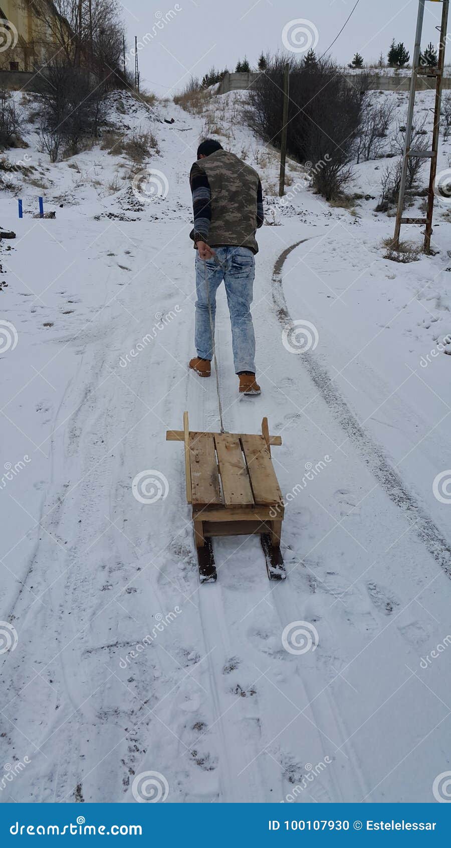 Guy is Carrying the Old Fashioned Hand Made Sled in the Snow Stock ...