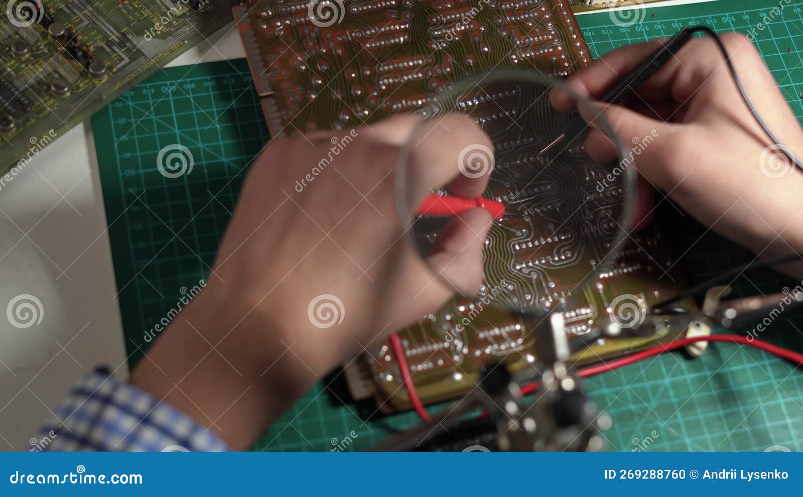 Guy Checking Circuit Board with Multimeter on Table at Home and ...