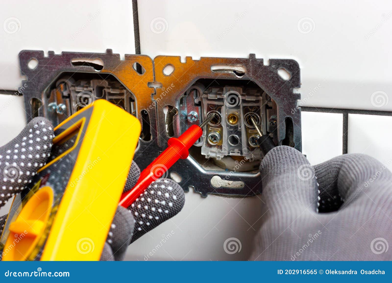 The Guy Checks the Voltage in the Disassembled Electrical Outlet with a ...