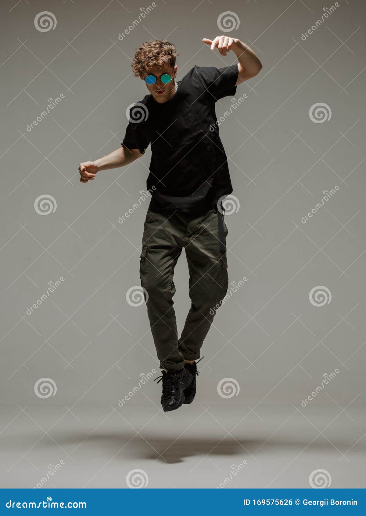 Guy Dancing Contemporary Dance in Studio. Neutral Grey Background ...