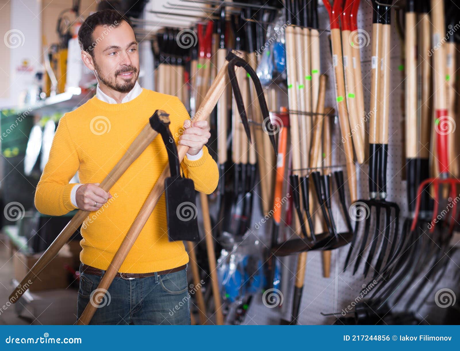 Guy deciding on best tools stock photo. Image of deciding - 217244856