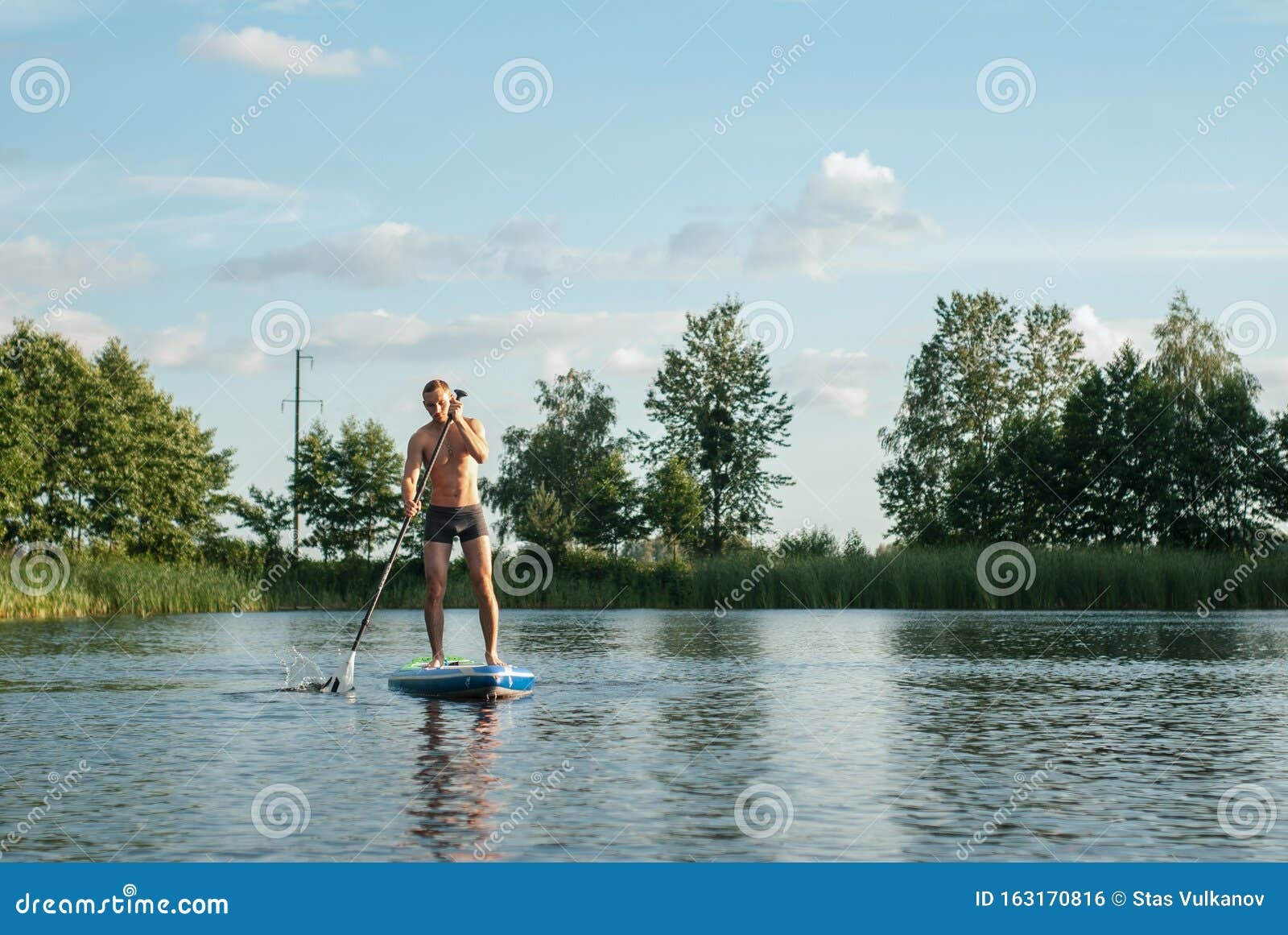 Guy Doing Paddle Boarding on Lake, Lucky Man on SUP Board Stock Photo ...