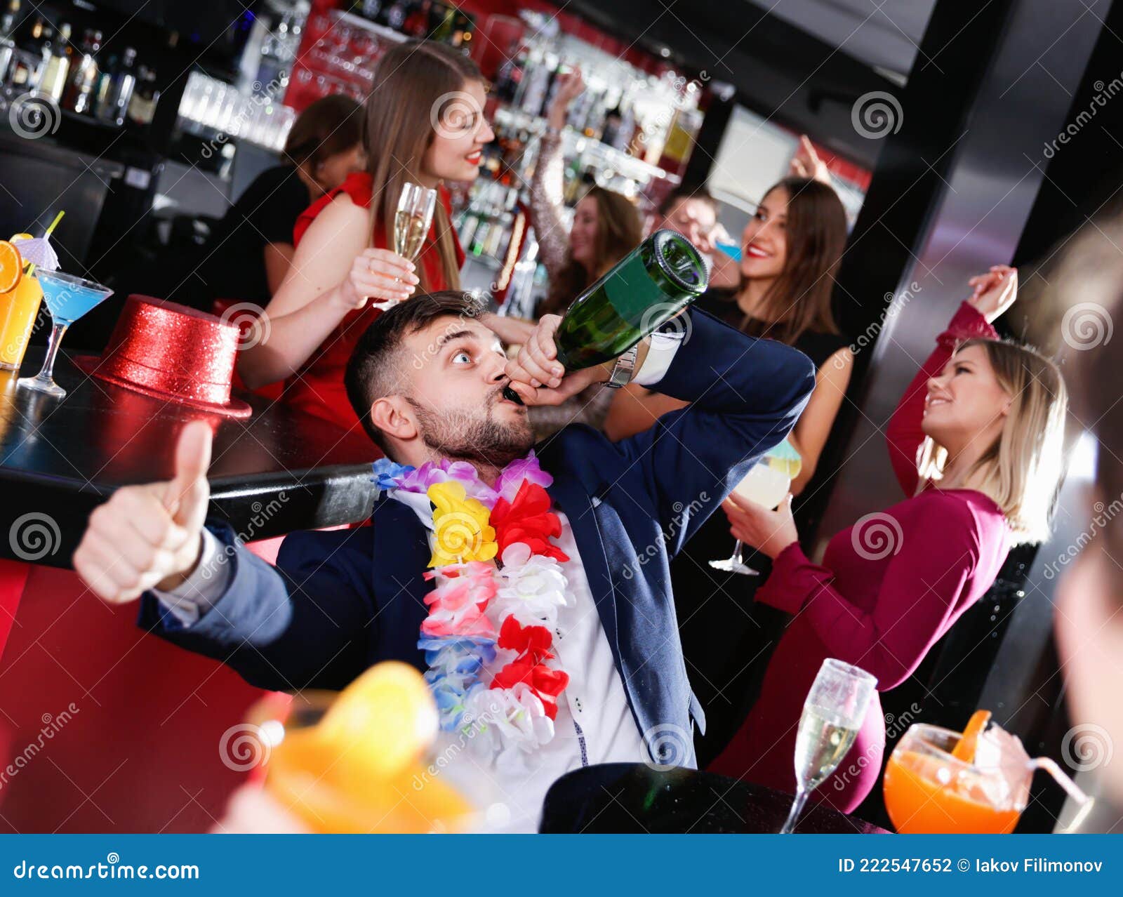 Guy Drinking Alcohol From Bottle And Dancing On Hawaiian Party At