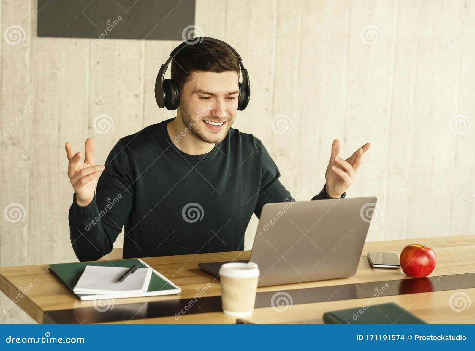 Guy in Earphones at Laptop Making Video Call in Office Stock Photo ...