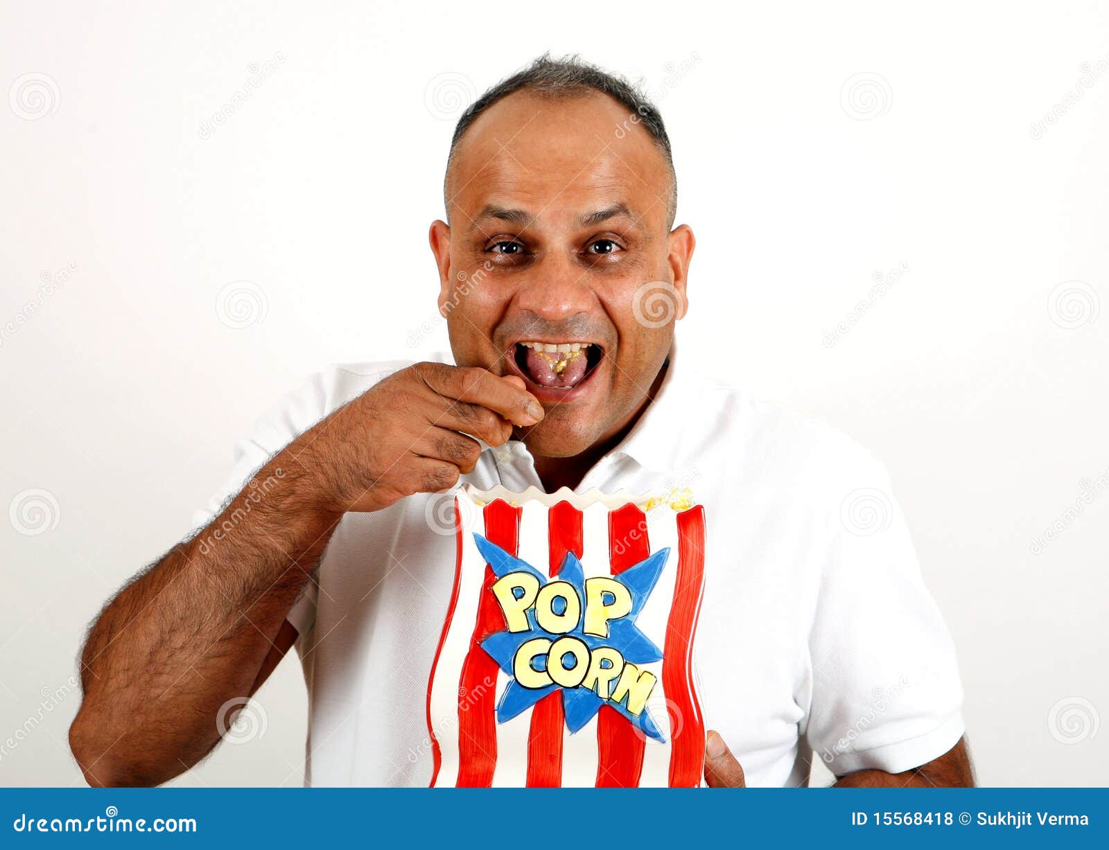 Guy eating popcorn stock photo. Image of eating, time - 15568418