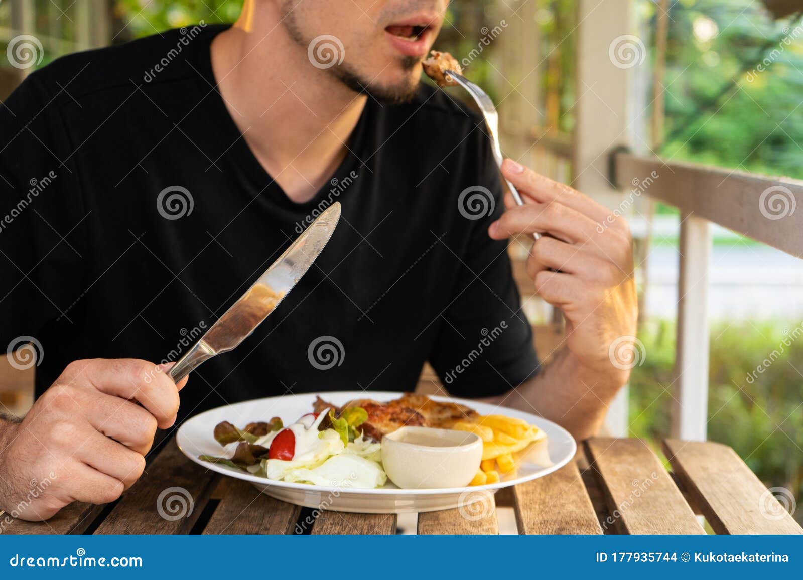 Guy Eating Steak at a Table in a Summer Cafe Stock Photo - Image of ...