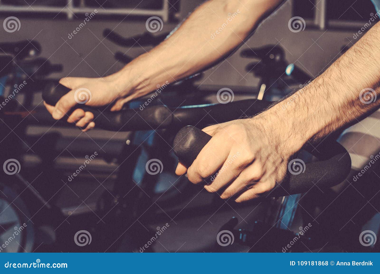 The Guy is Engaged in a Bicycle Simulator in the Gym. Toned Image Stock ...