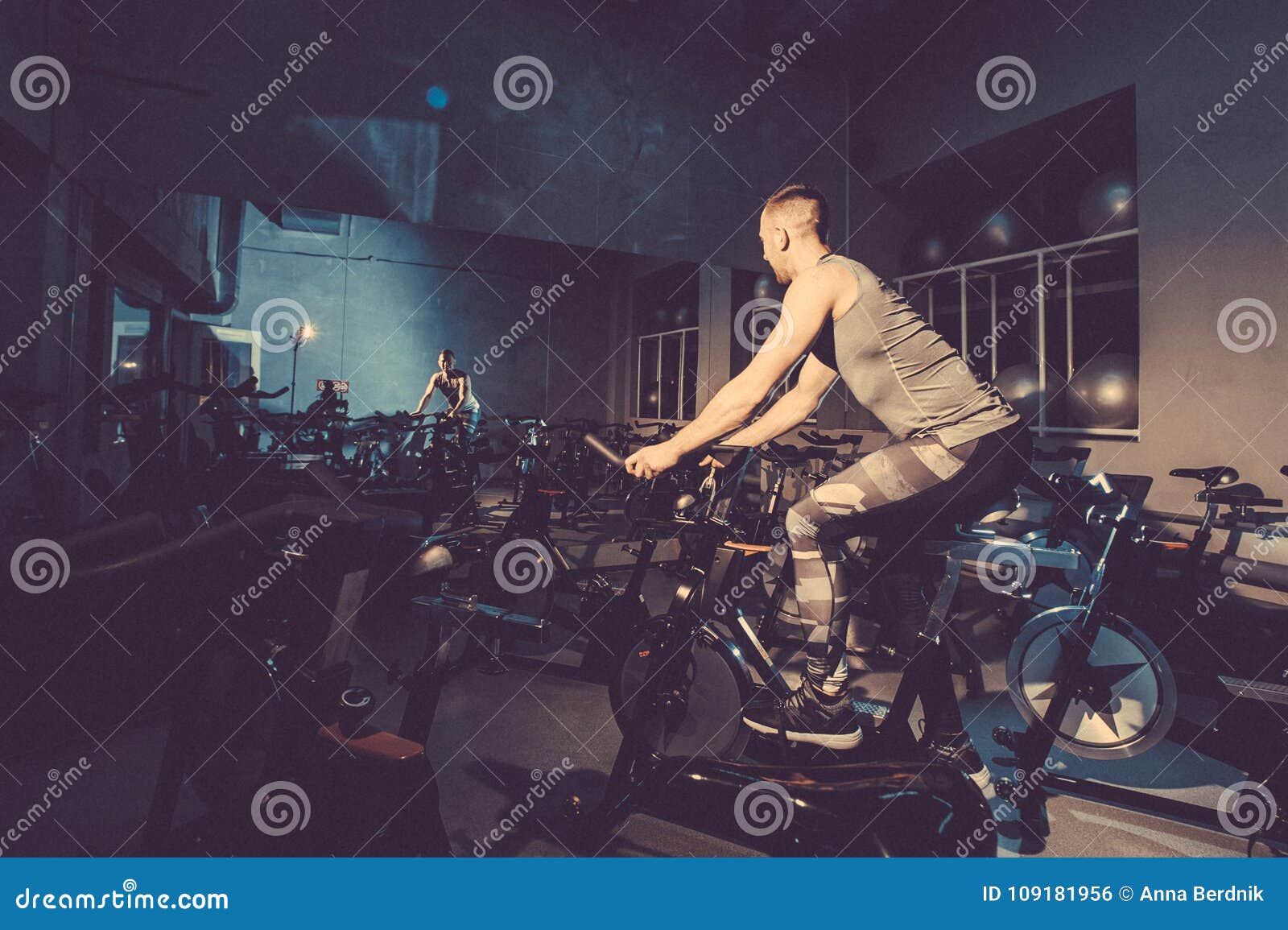 The Guy is Engaged in a Bicycle Simulator in the Gym. Toned Image Stock ...