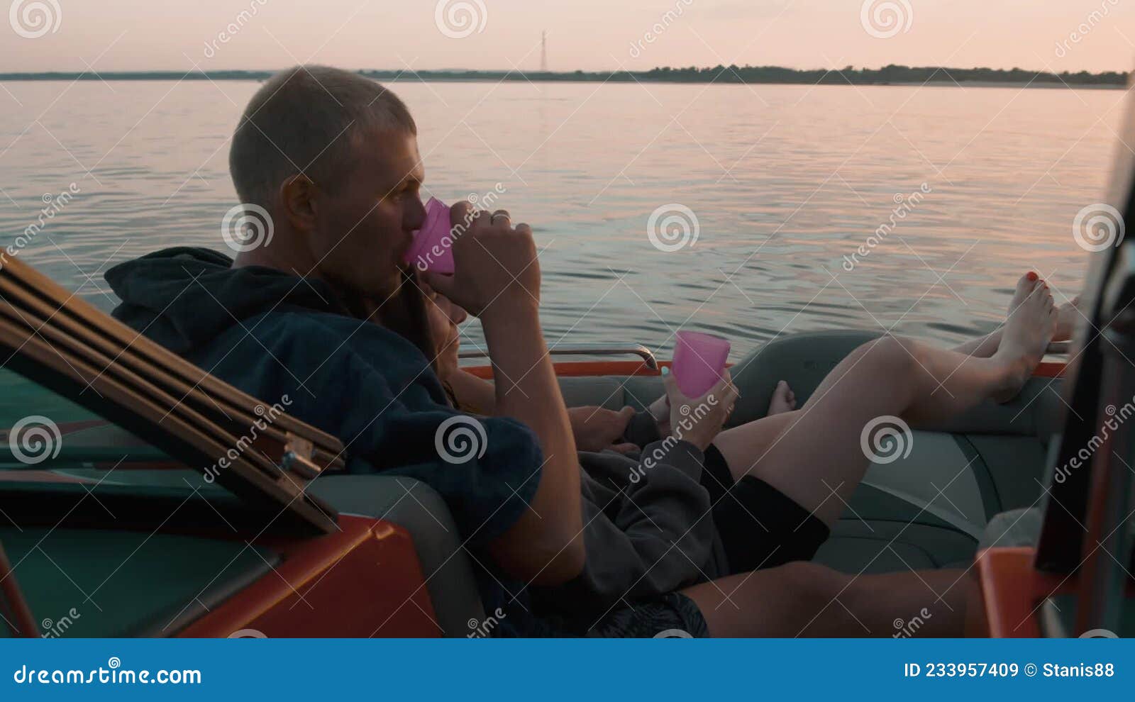 A Guy and a Girl Cuddle Cute at Sunset Sitting in a Boat Stock Video ...