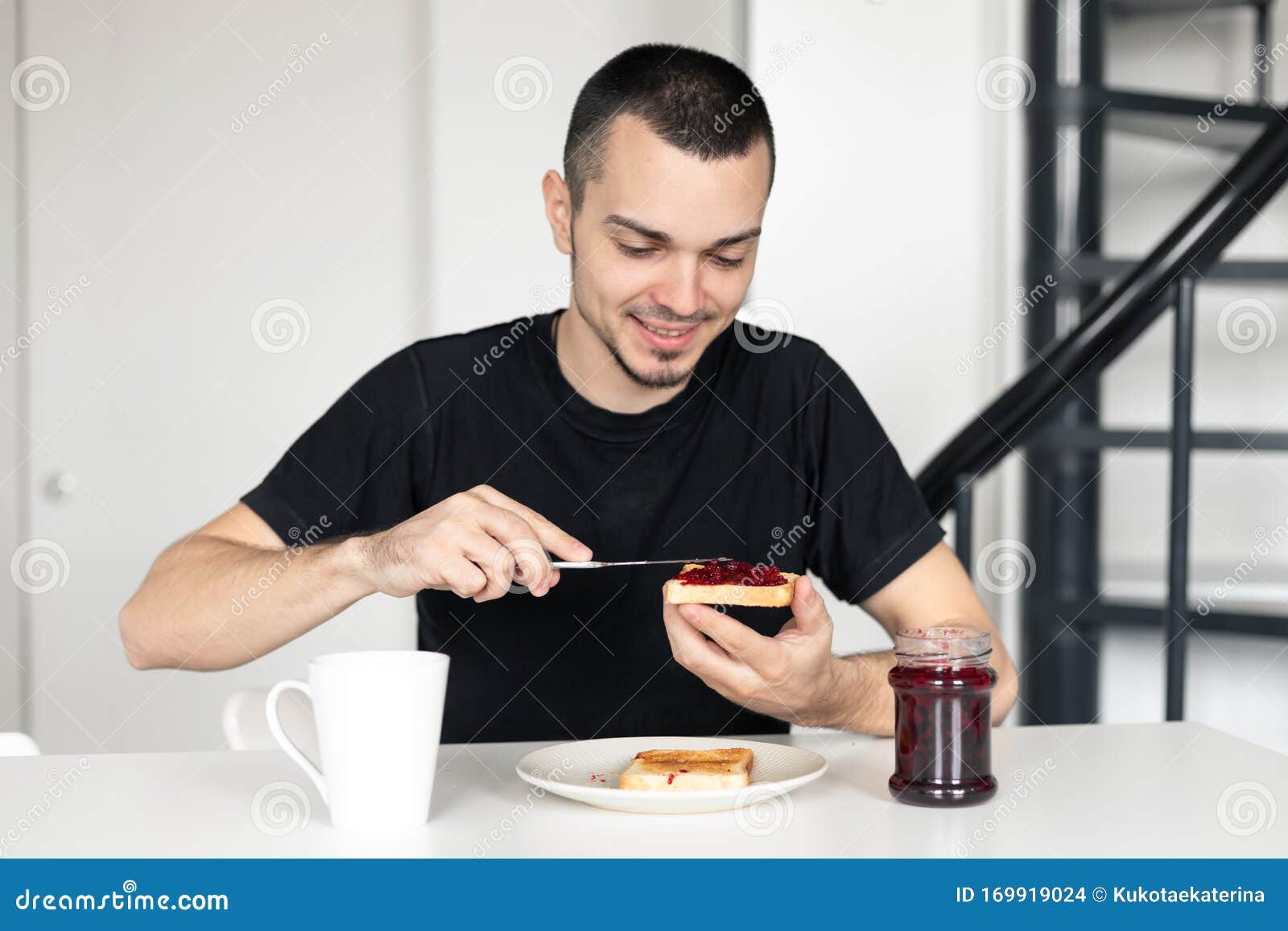 The Guy Has Breakfast with Toast with Jam Stock Photo - Image of male ...