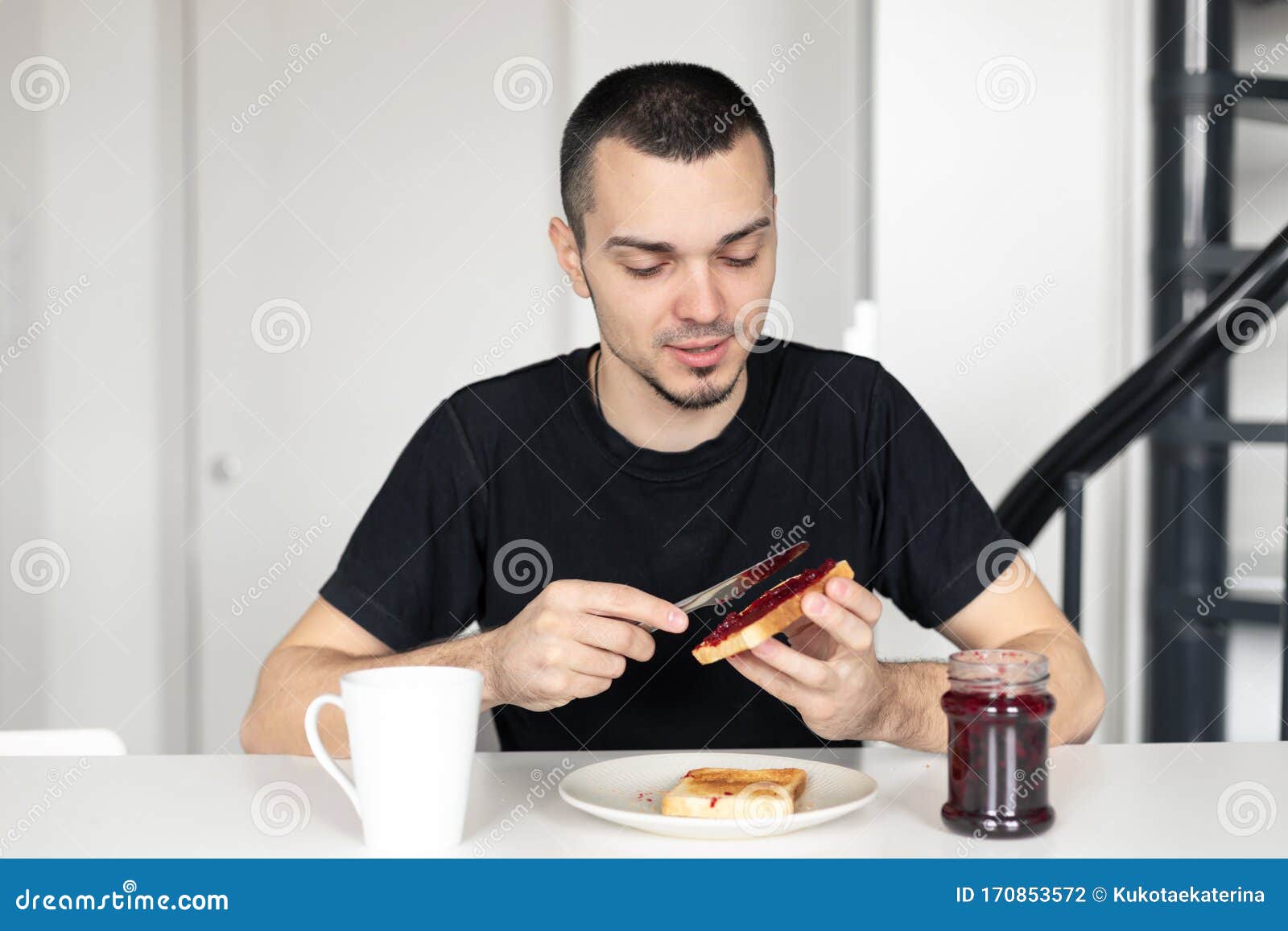 The Guy Has Breakfast with Toast with Jam Stock Photo - Image of hand ...