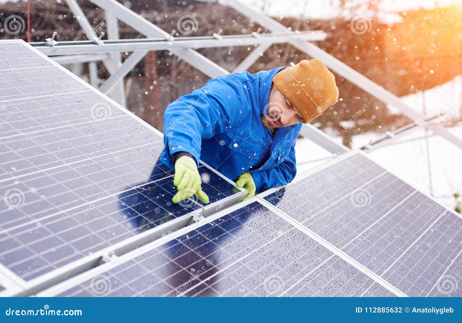 Guy with Help of Tools Installs Solar Panels, Snowy Weather Stock Photo ...
