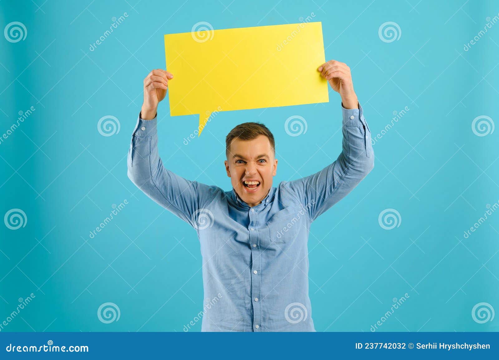 Guy Holding Speech Bubble on Blue Studio Background, Mockup for Design ...