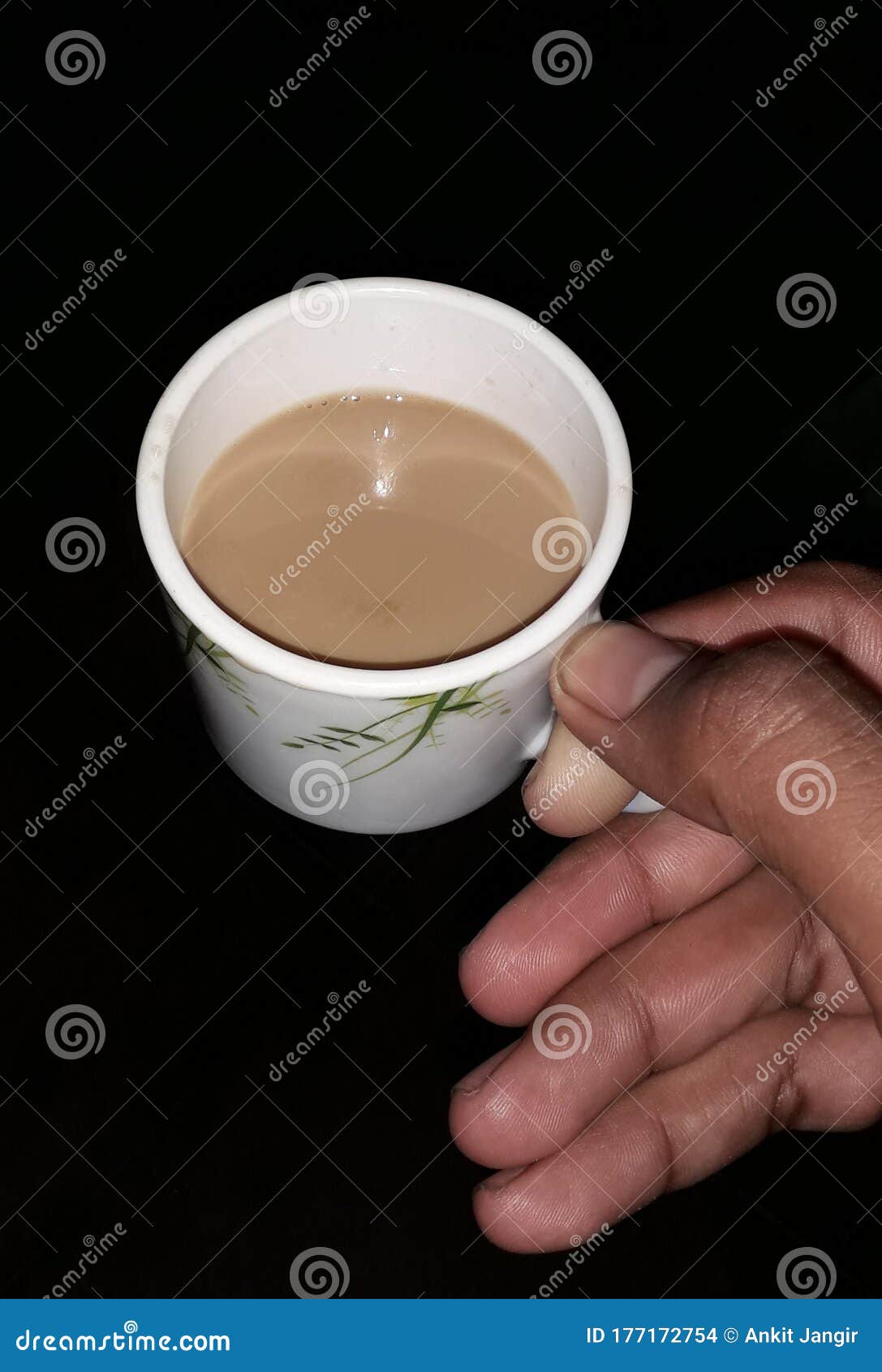 A Guy is Holding Tea Cup in His Hand in Black Background Stock Photo ...