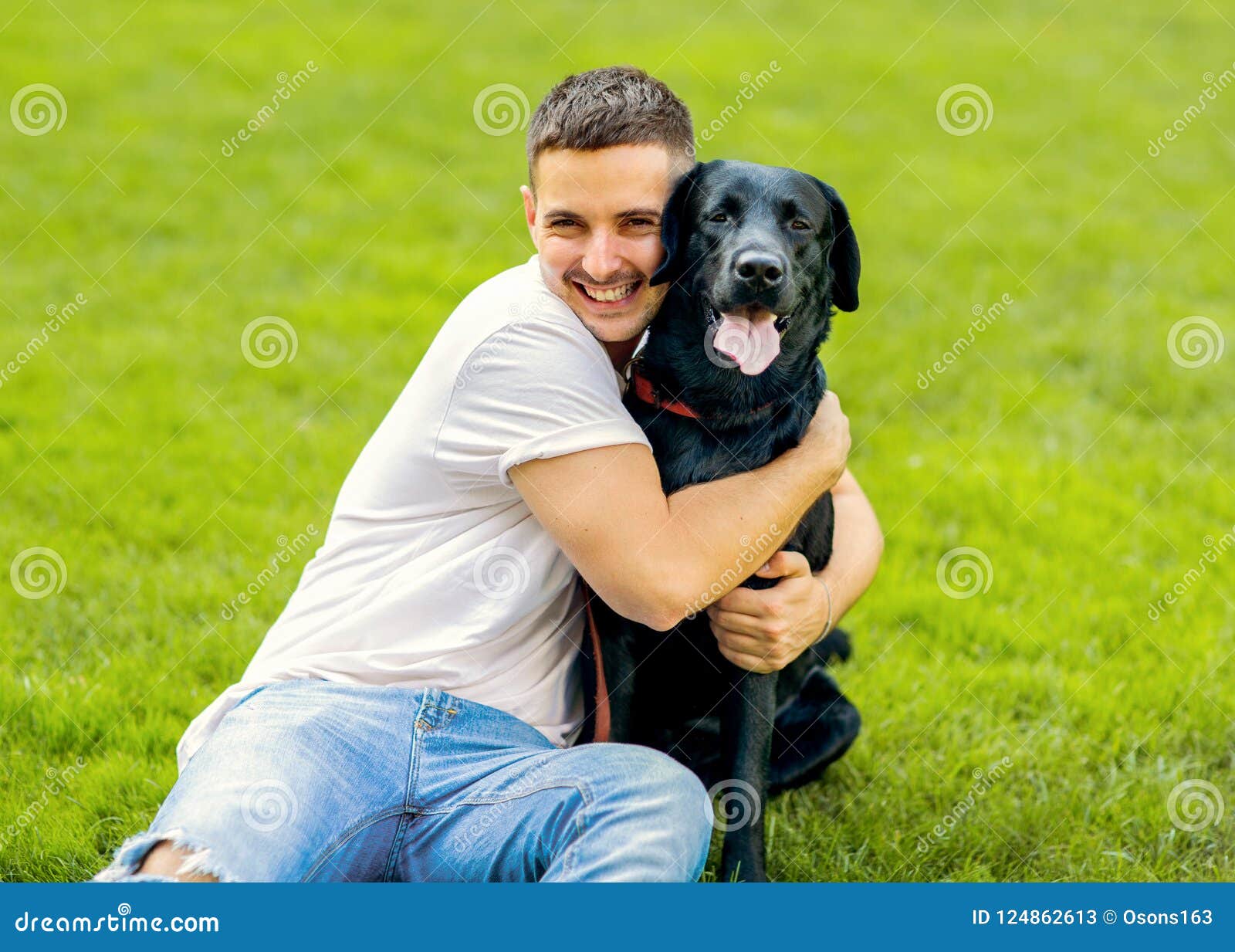 Guy Hugging with His Dog Labrador Playing in the Park Stock Image ...