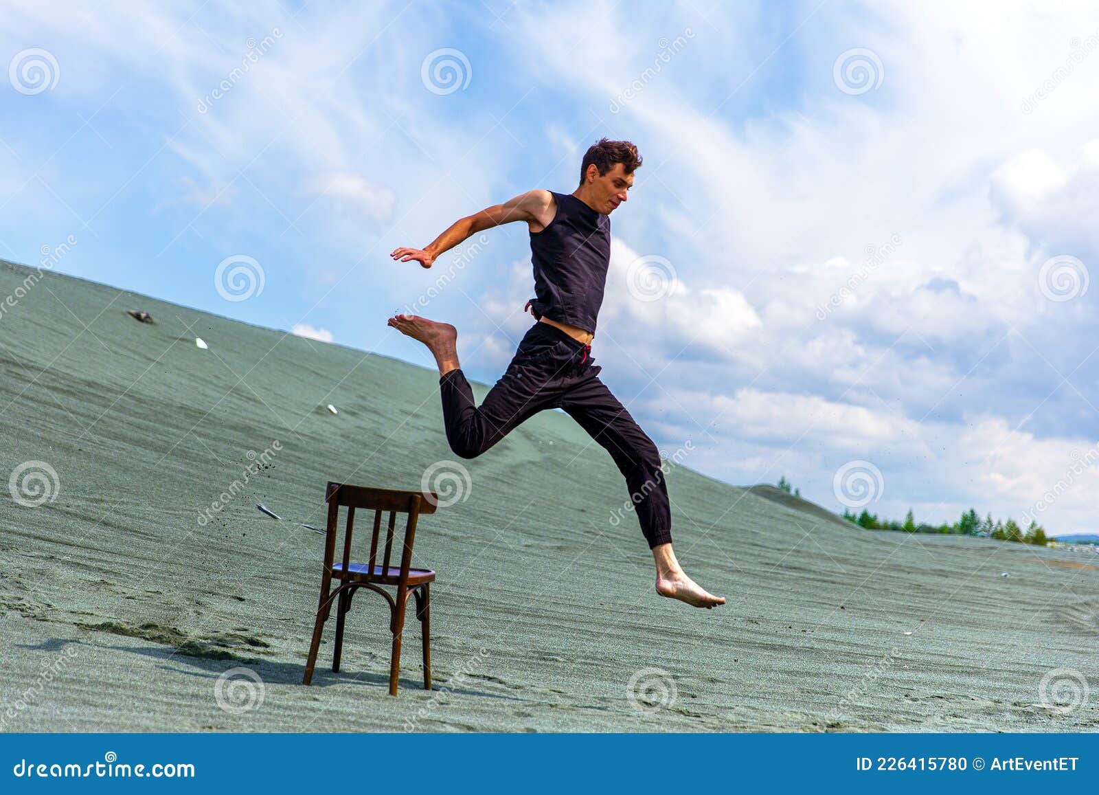 Guy Jumping Over Chair in the Desert Stock Photo - Image of young ...