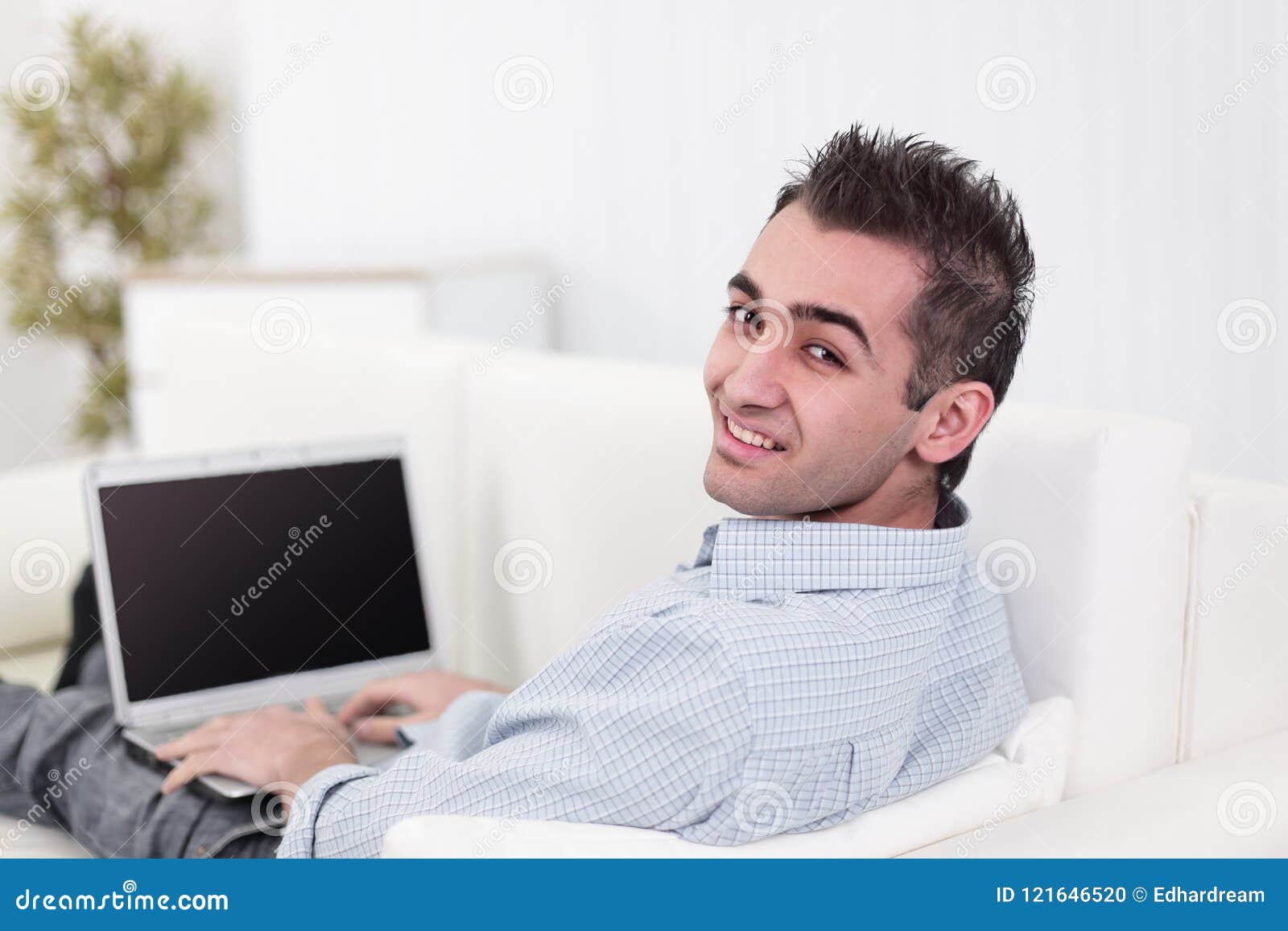 Handsome Man is Using a Laptop, Looking at Camera and Smiling Stock ...