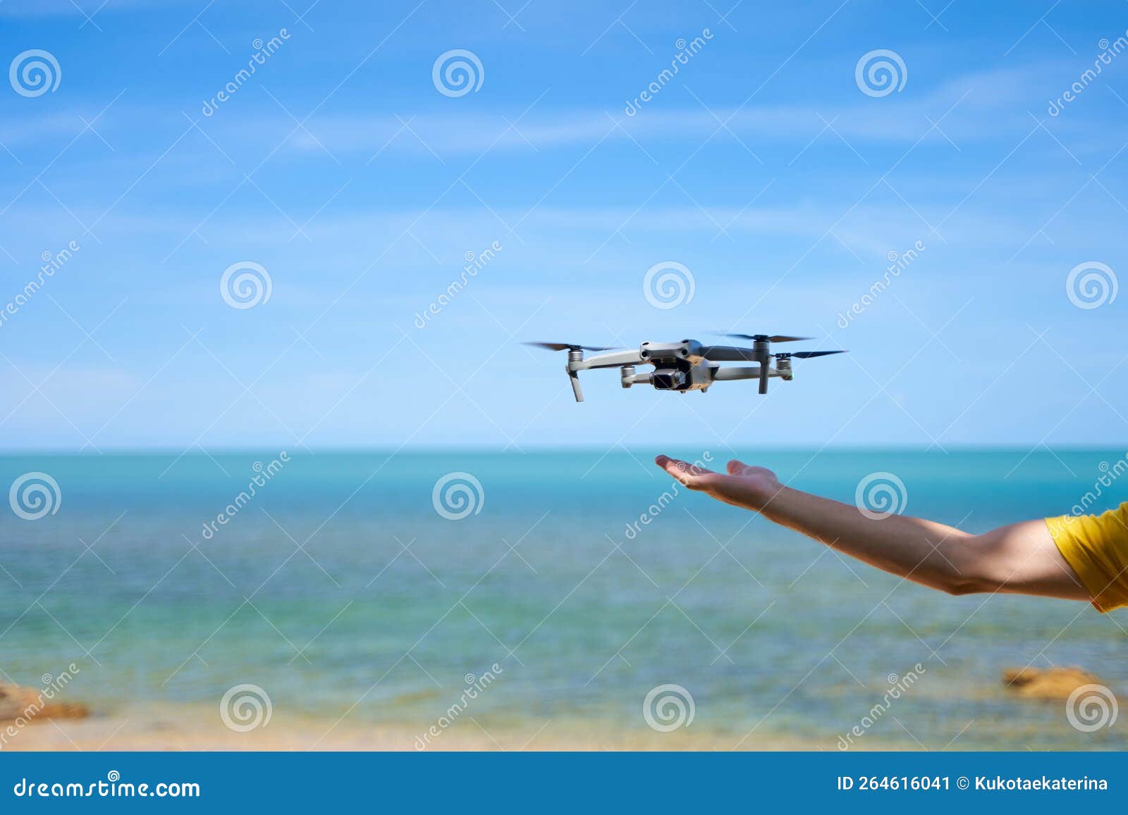 A Guy Launches from the Arm of a Prone on the Seashore Stock Image ...